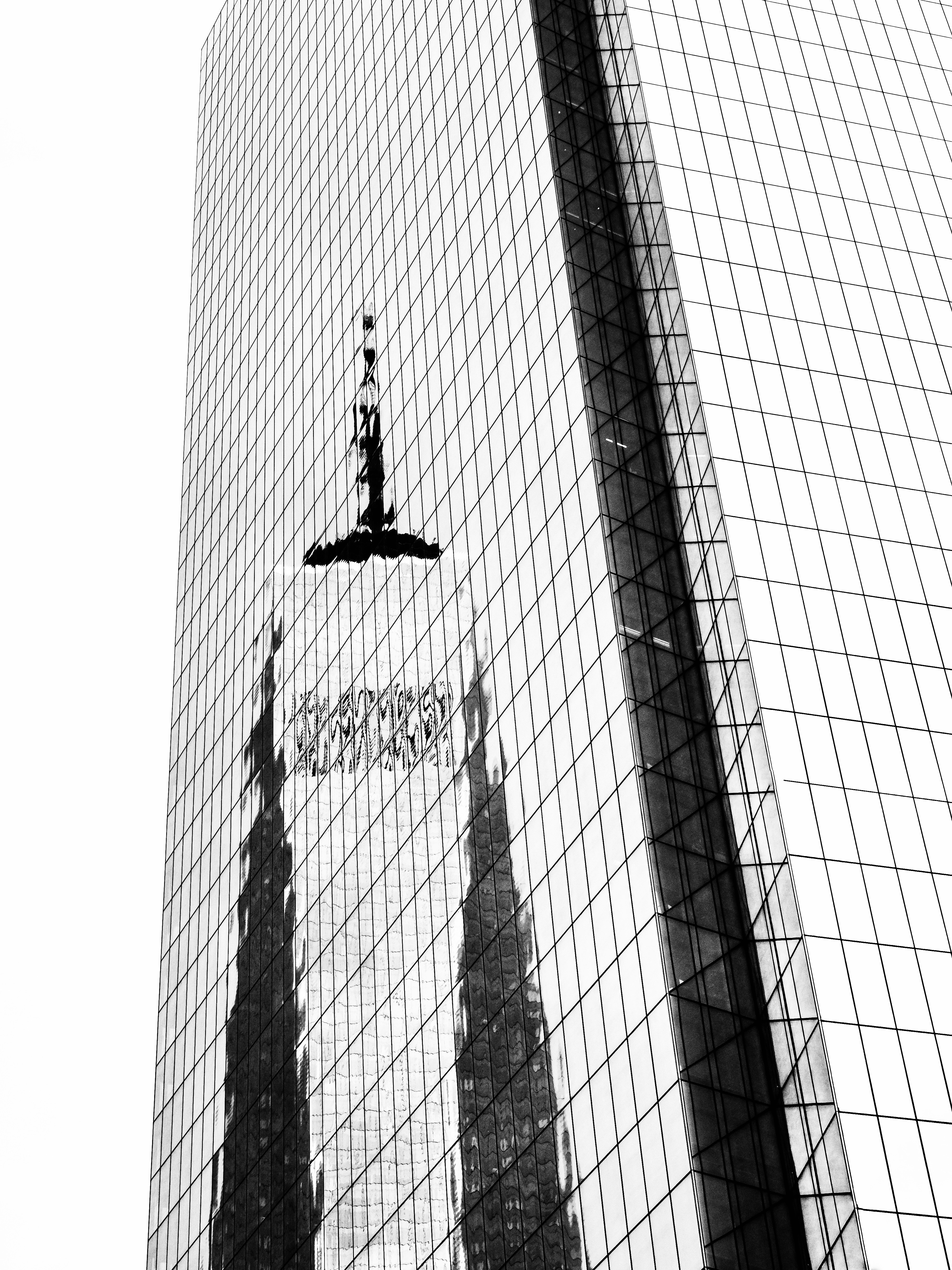 Glass Facade, Twin Spires: A Monochrome City Reflection