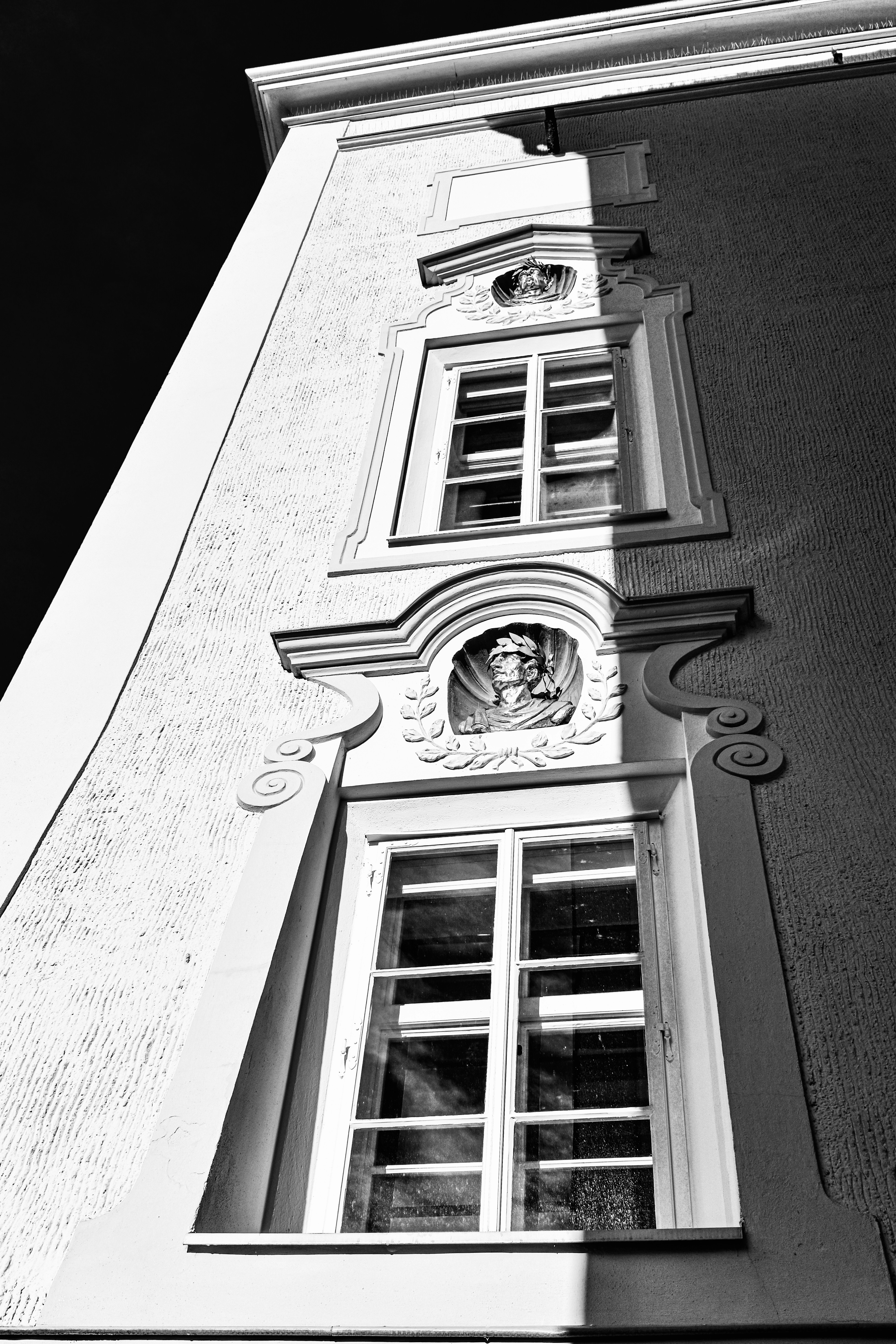 Facade in Contrast: Diagonal Sunlit Ornament Meets Shadowed Brick