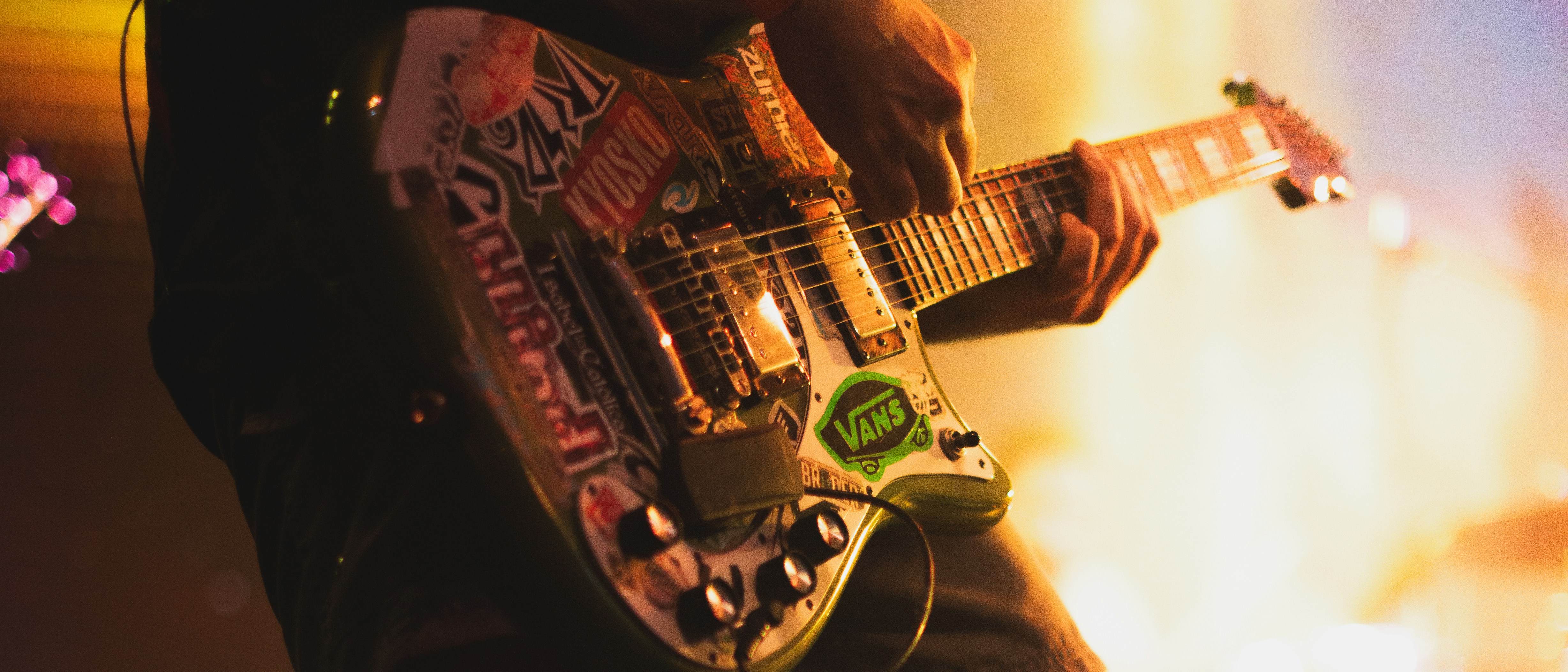 Stickered Strat: A Guitarist's Crafted Moment on Stage