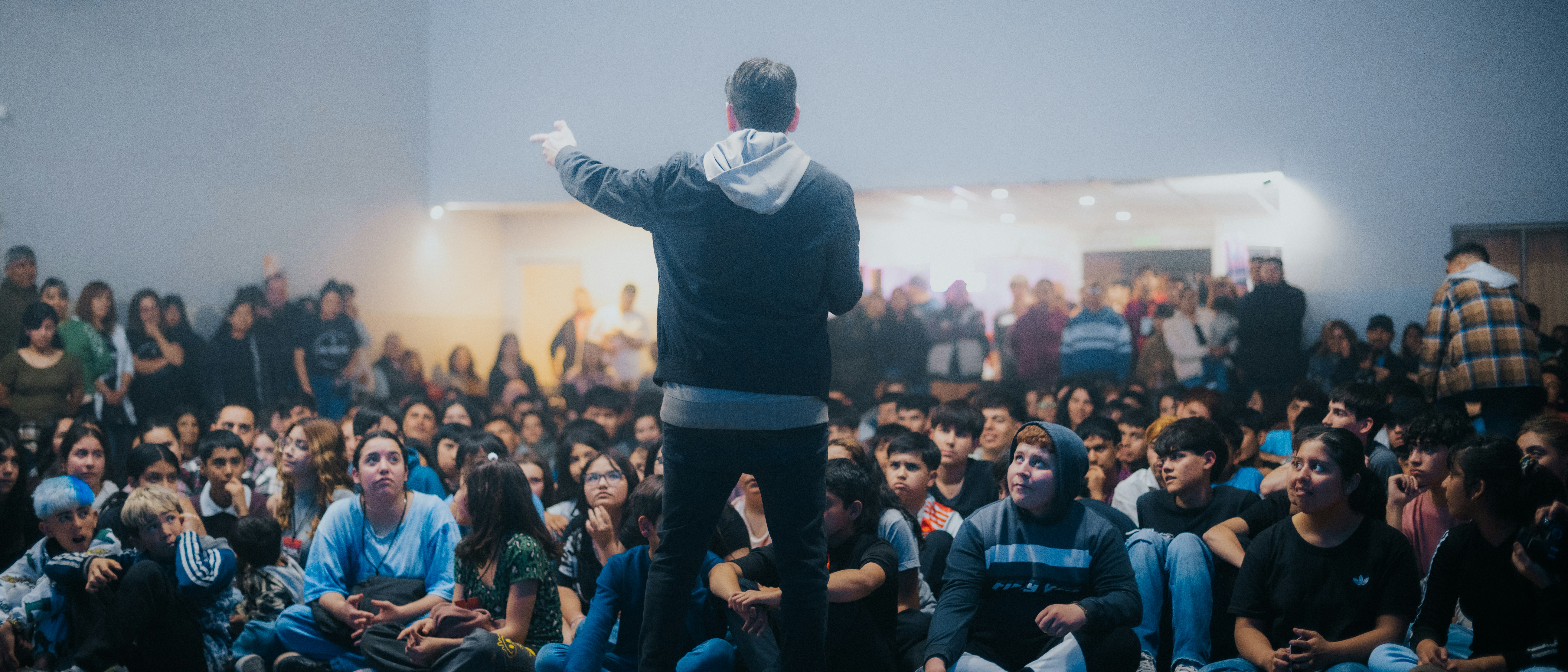 The Conductor Before the Crowd: A Leader Addressing a Sea of Attendees