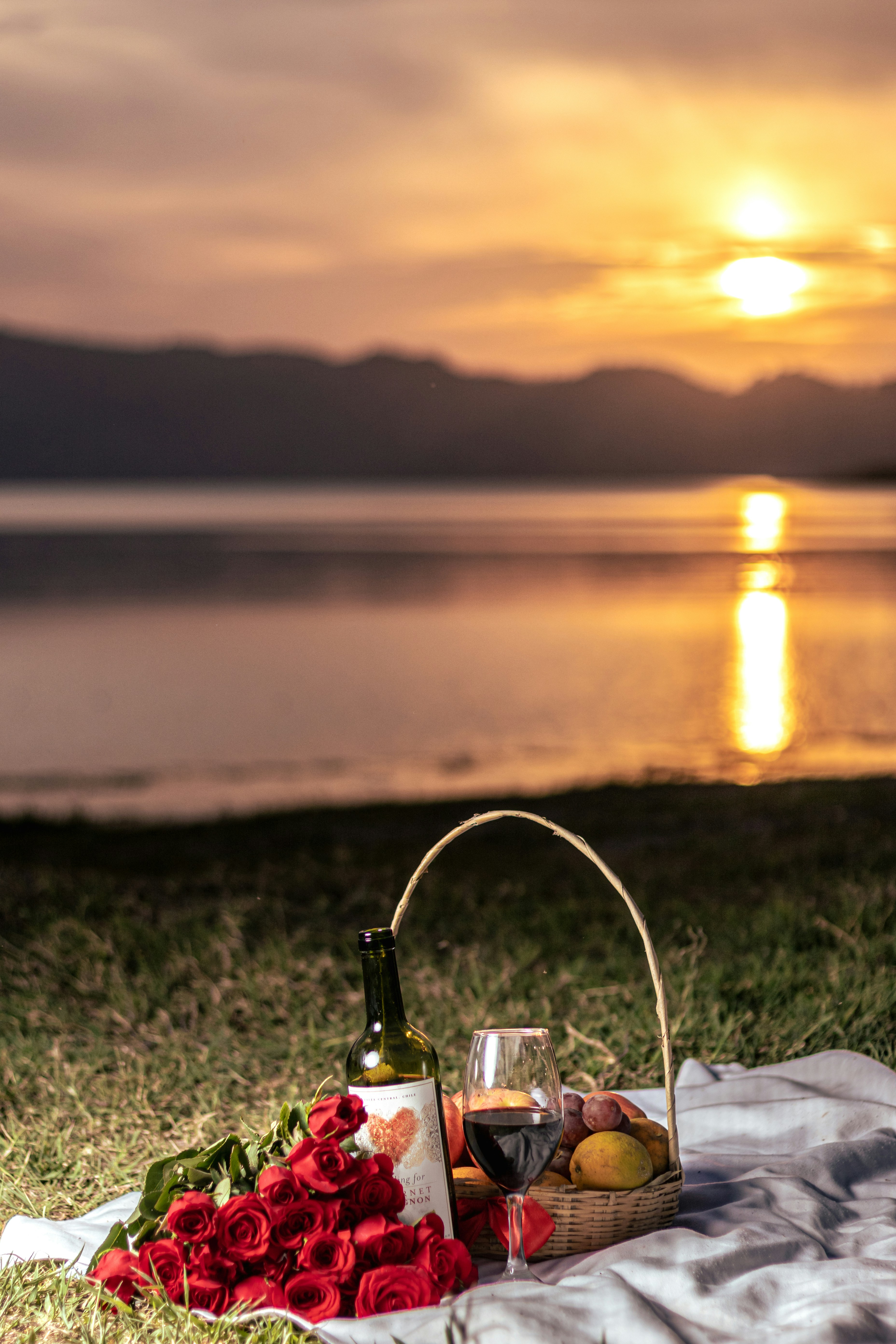 Romantic picnic by the water at sunset