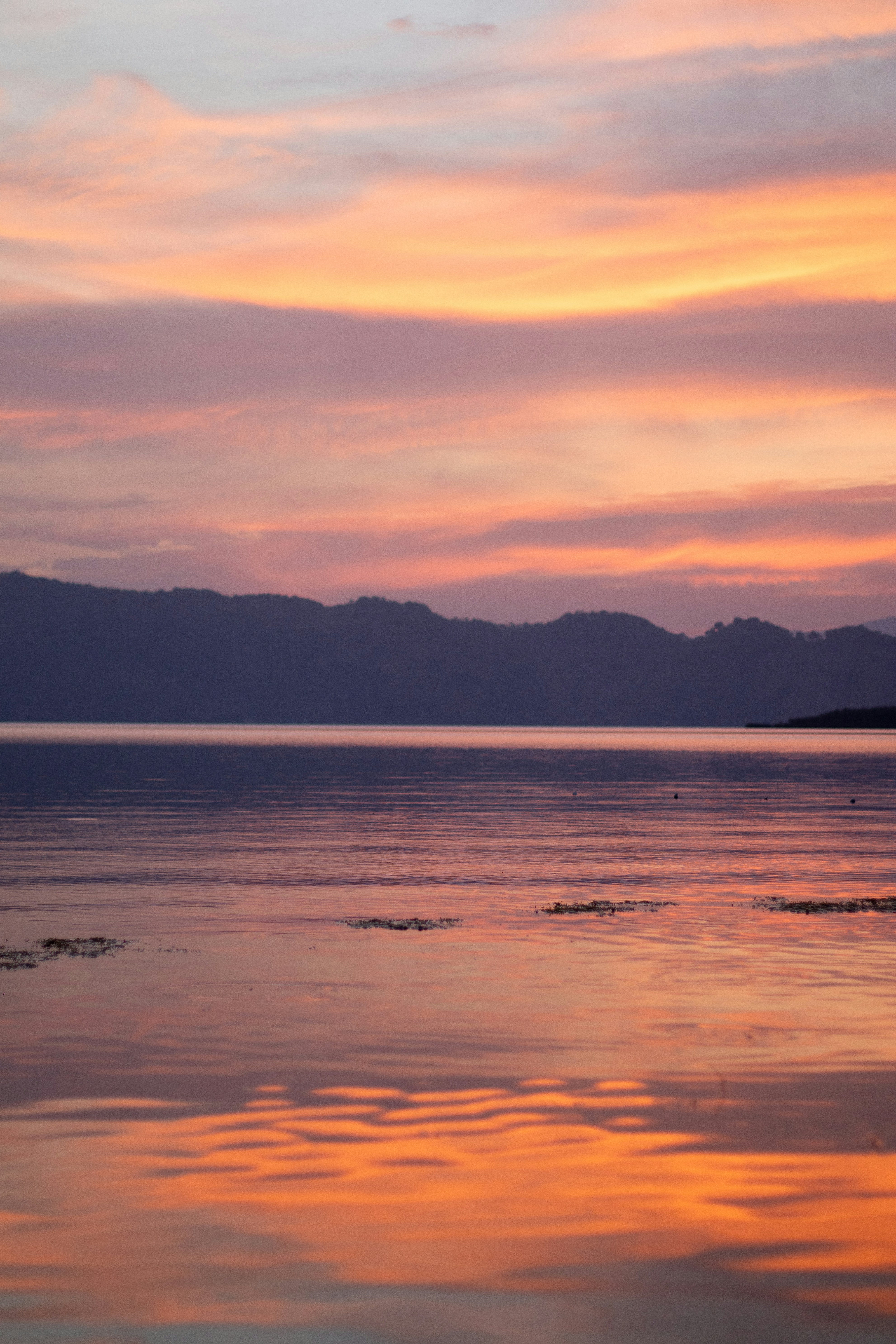 Horizon Flames: Quiet Sunset Over Calm Seas