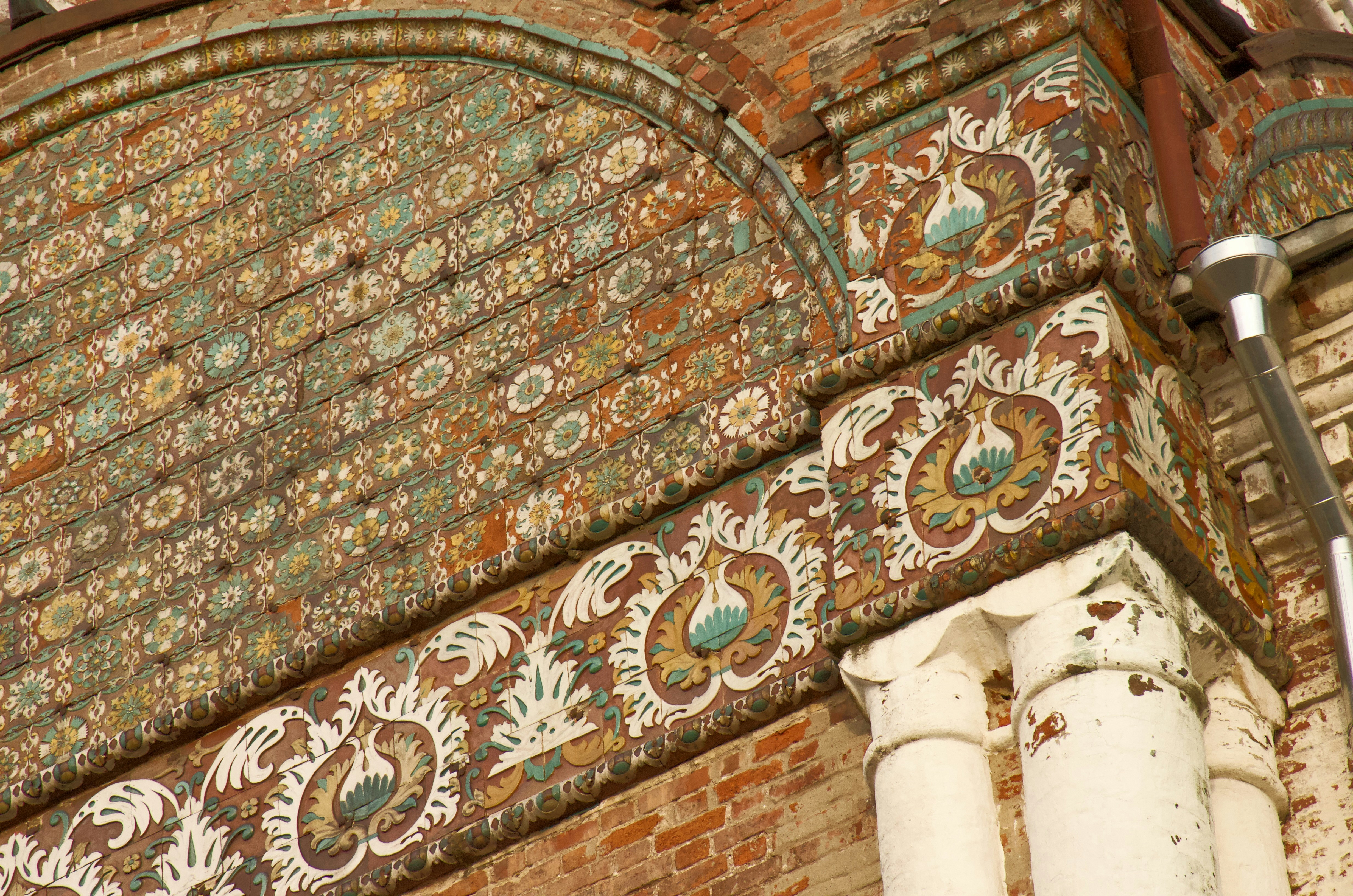 Ornate Terracotta Frieze and Weathered Columns Embracing Brickwork