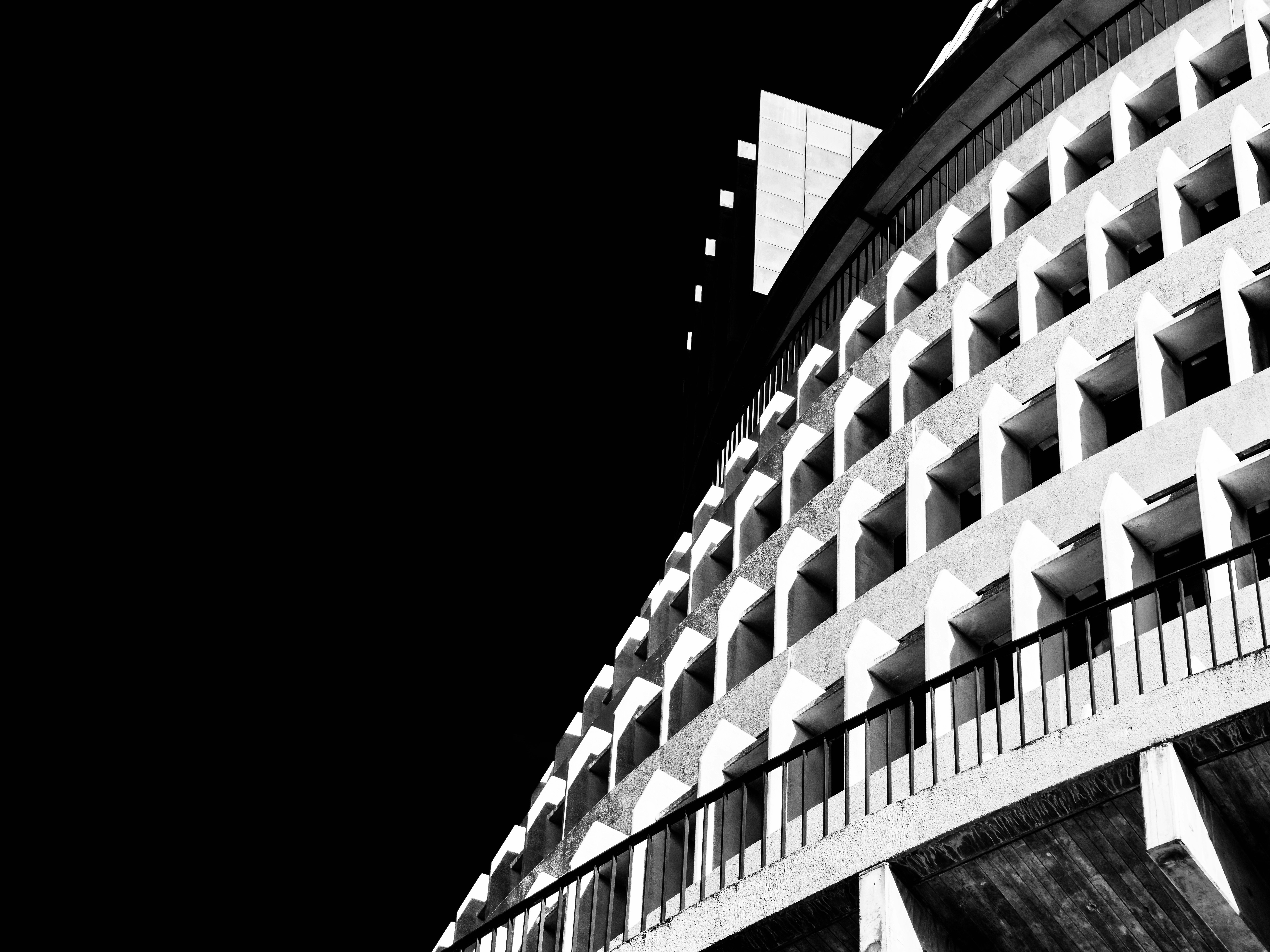 Monochrome Facade: Repetitive Grid of Shadows on a Curved Building