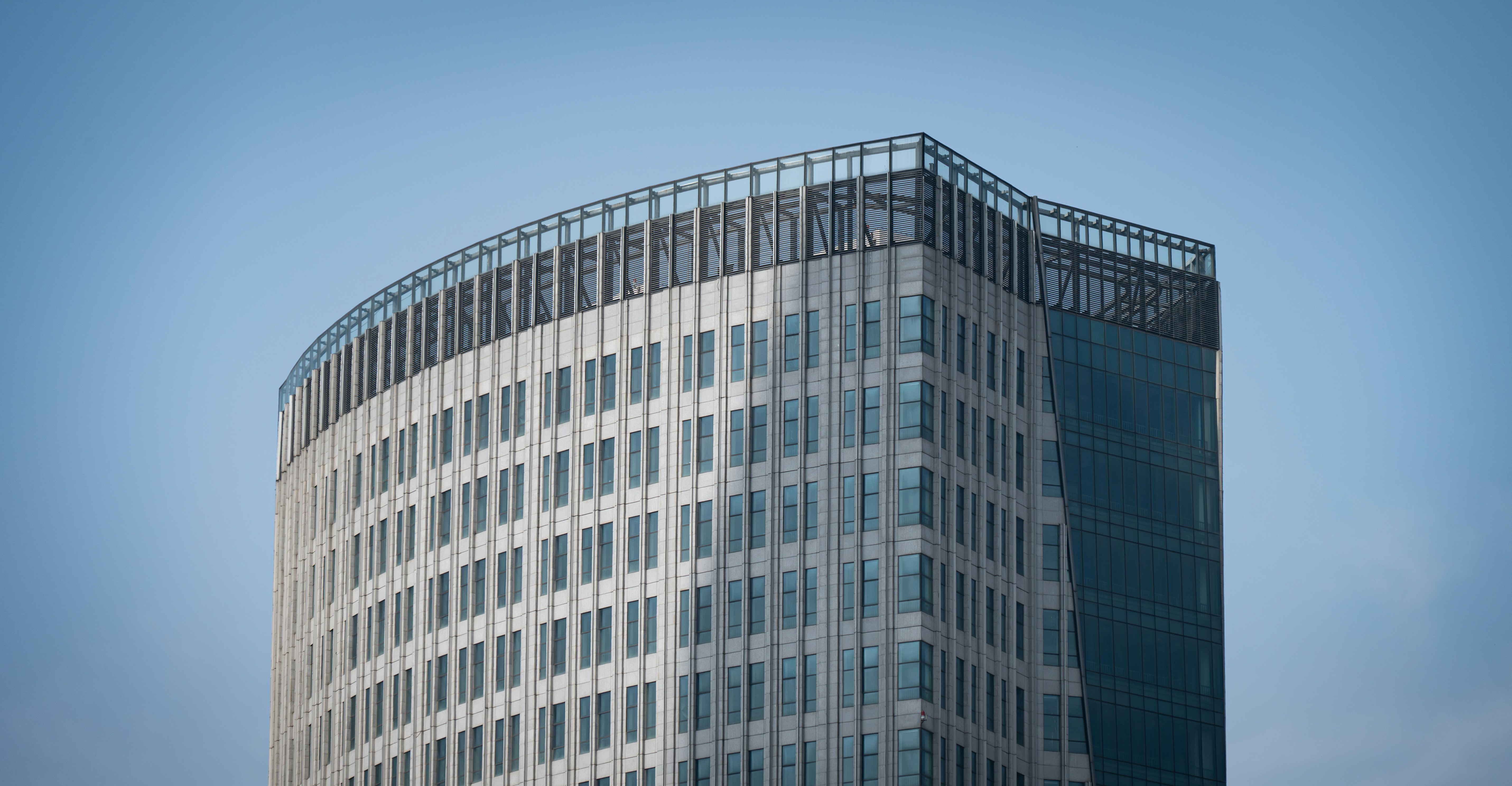 Curved Glass Tower Rises Above a Clear Sky