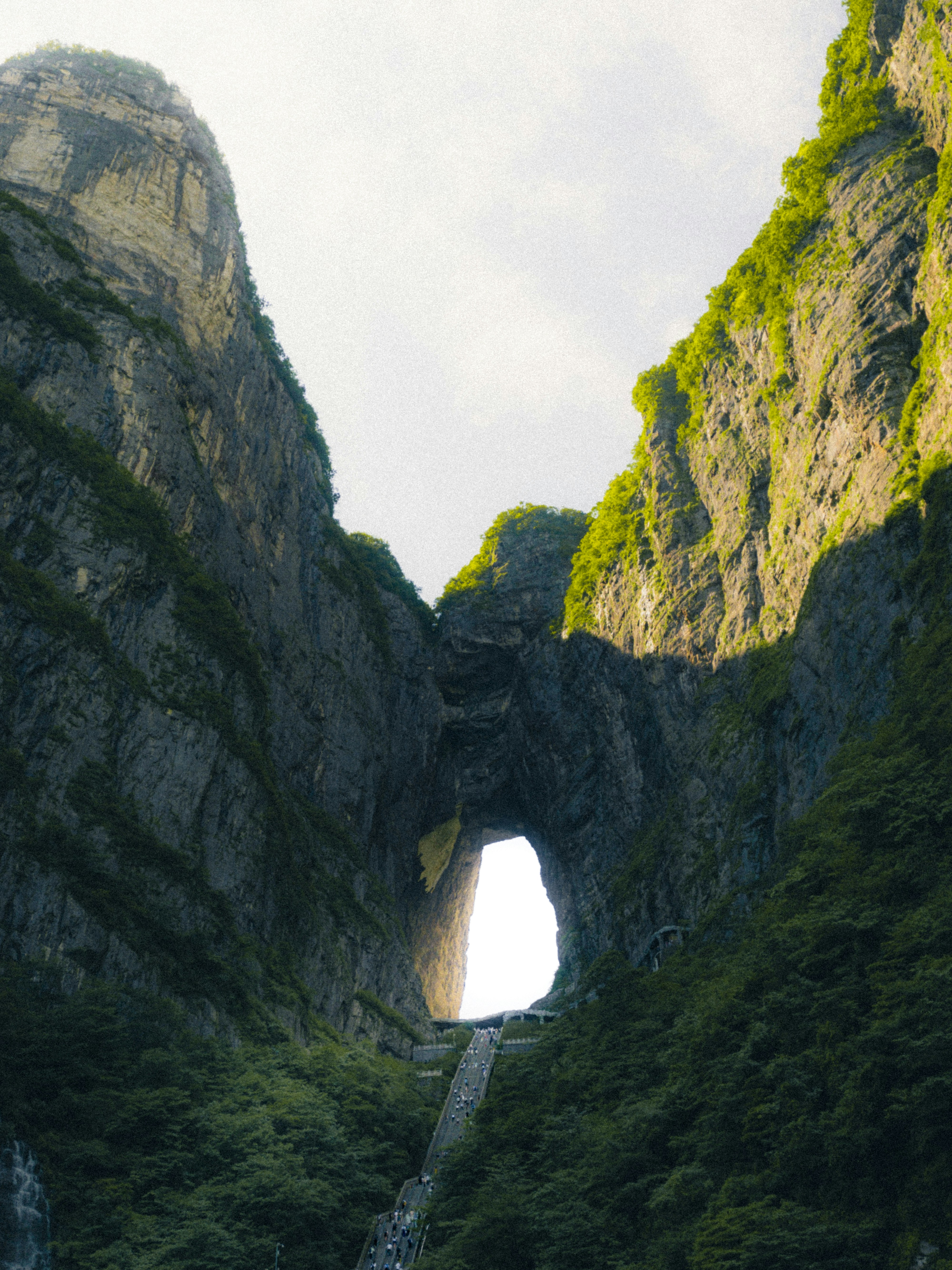 Gate through the Gorge: Natural Arch Framed by Towering Cliffs