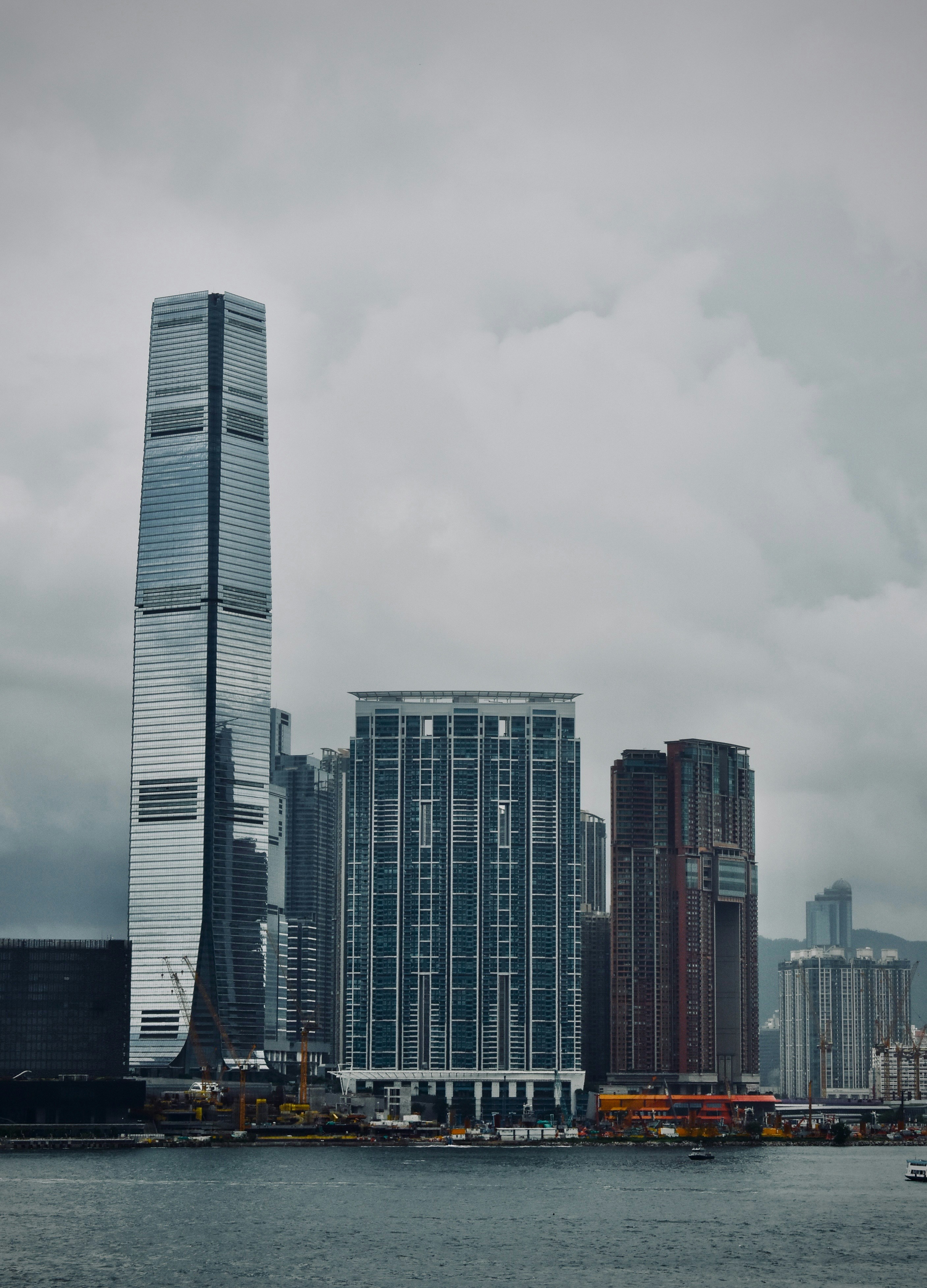 Vertical Giant Over Harbor: A City Silhouette Rising