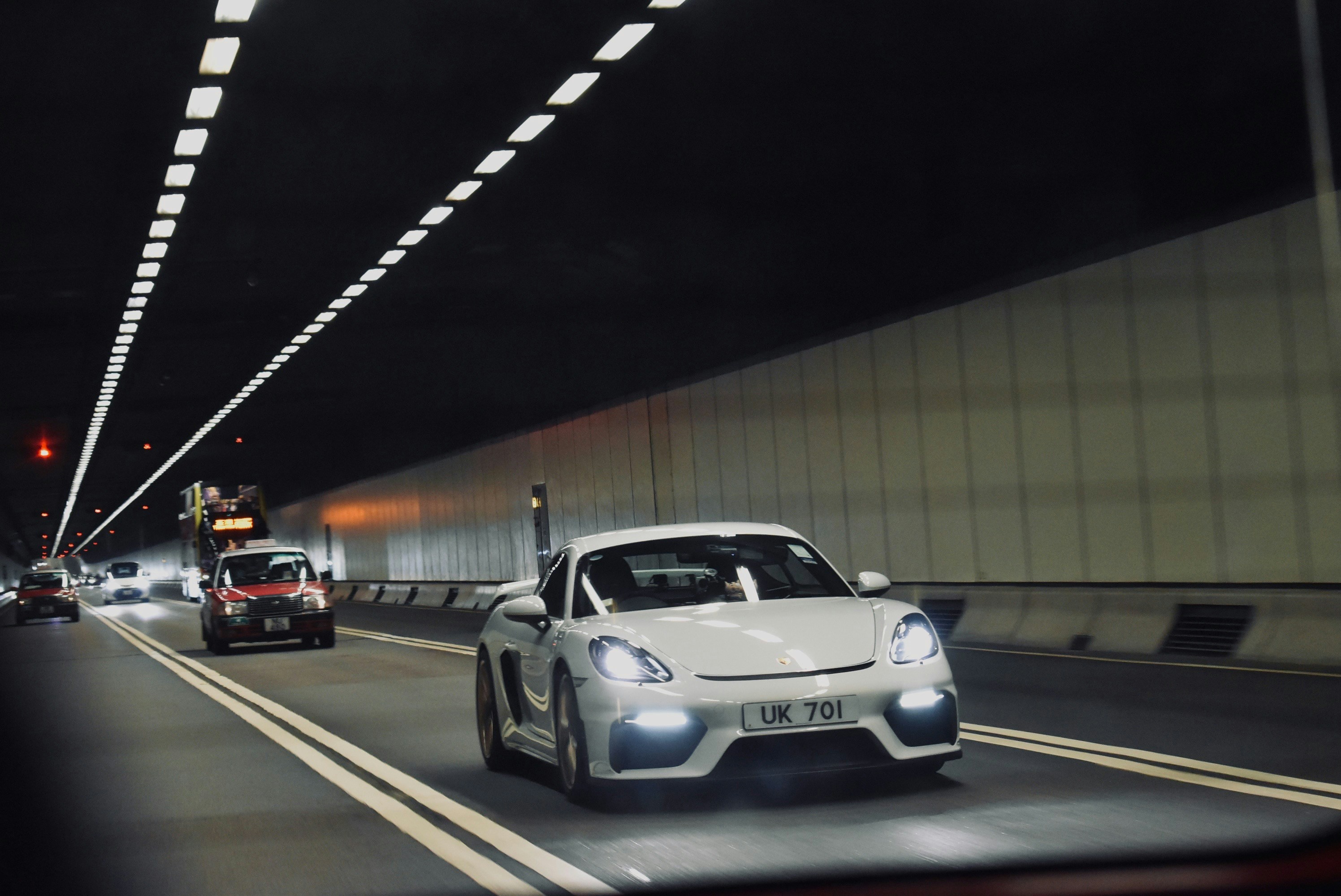 Silver Porsche Leads Through the Tunnel Cadence