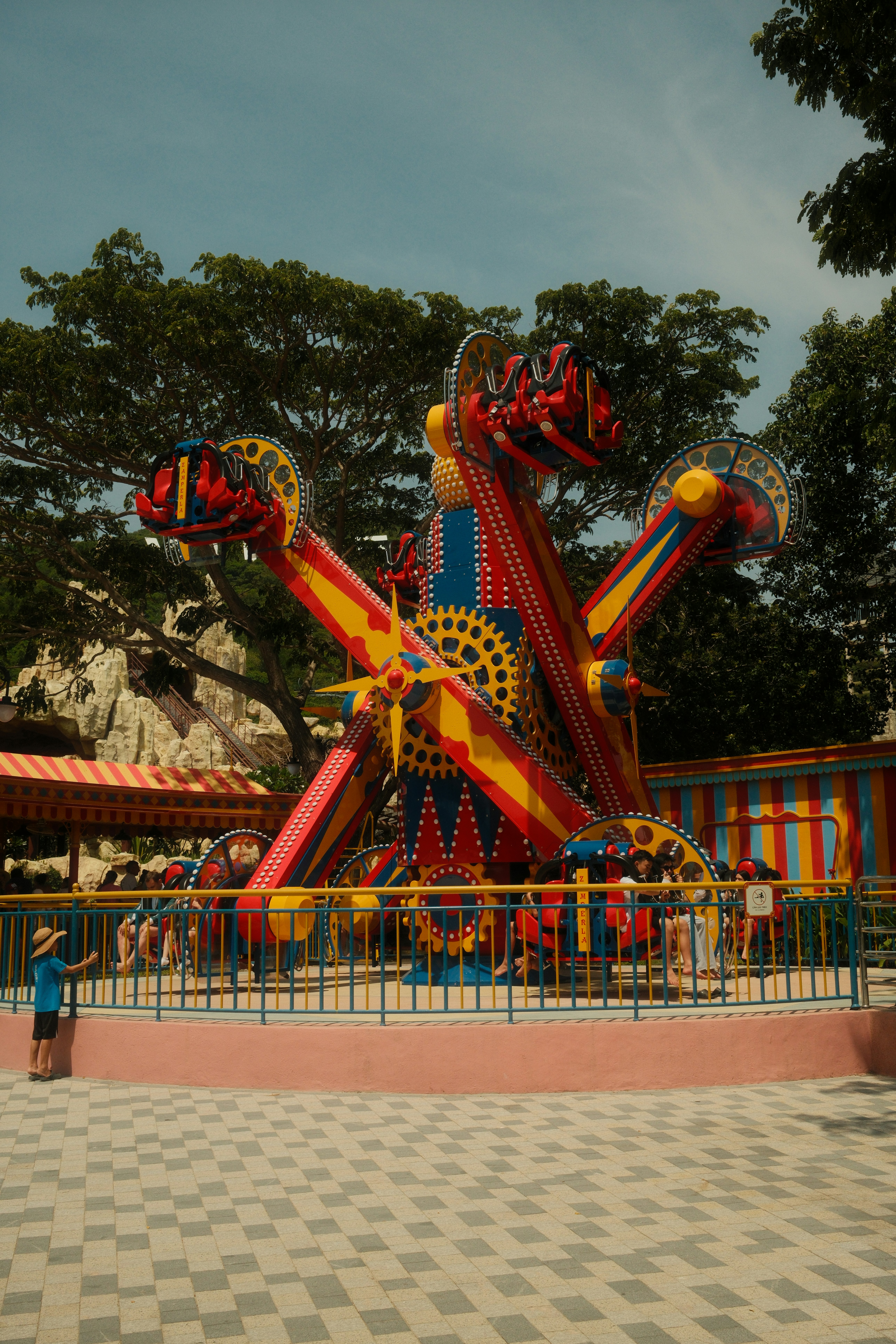 Colorful Tilt-A-Whirl at a Sunny Amusement Park
