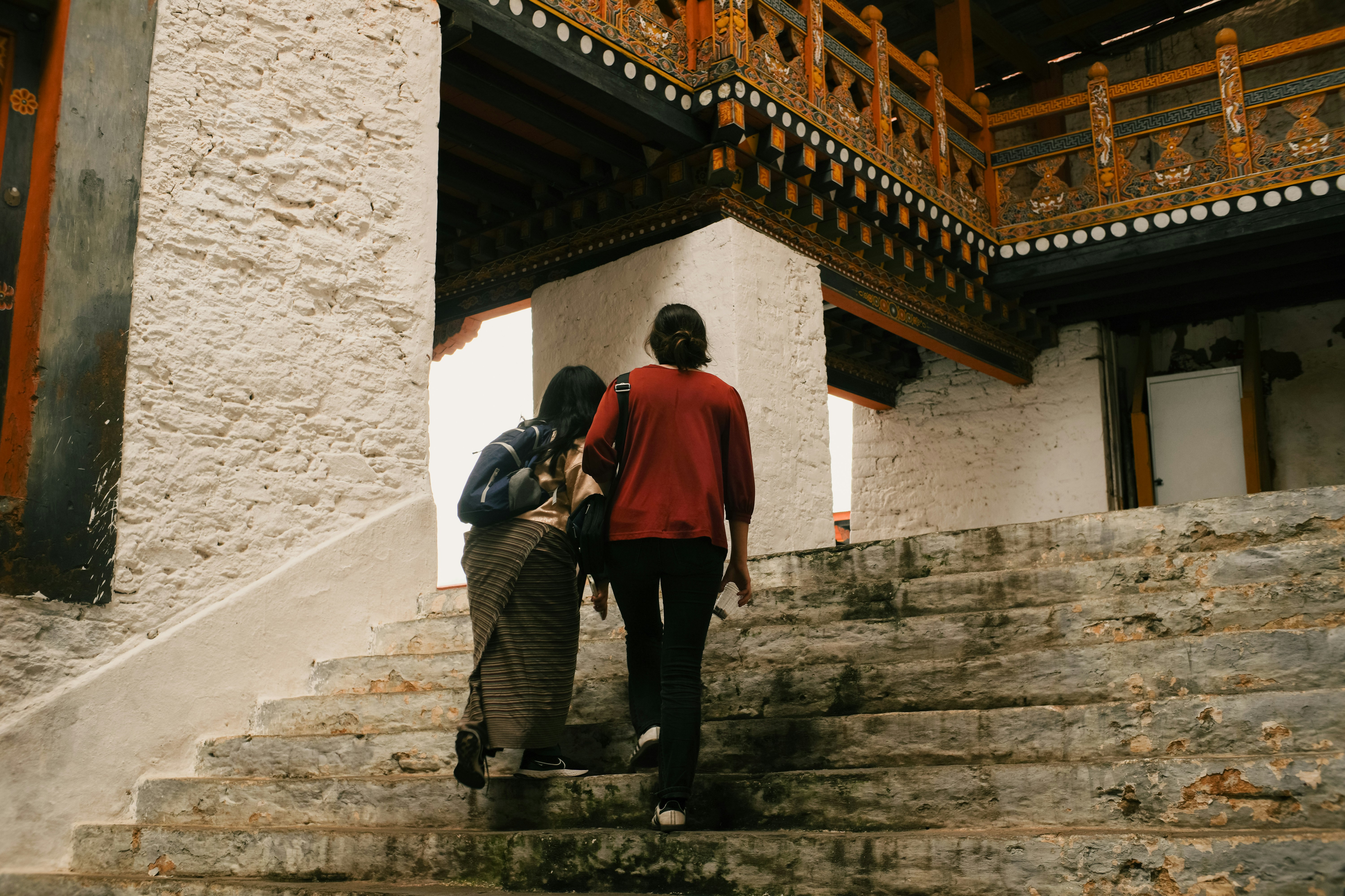 Quiet ascent: Two travelers carve a path up ancient stone stairs