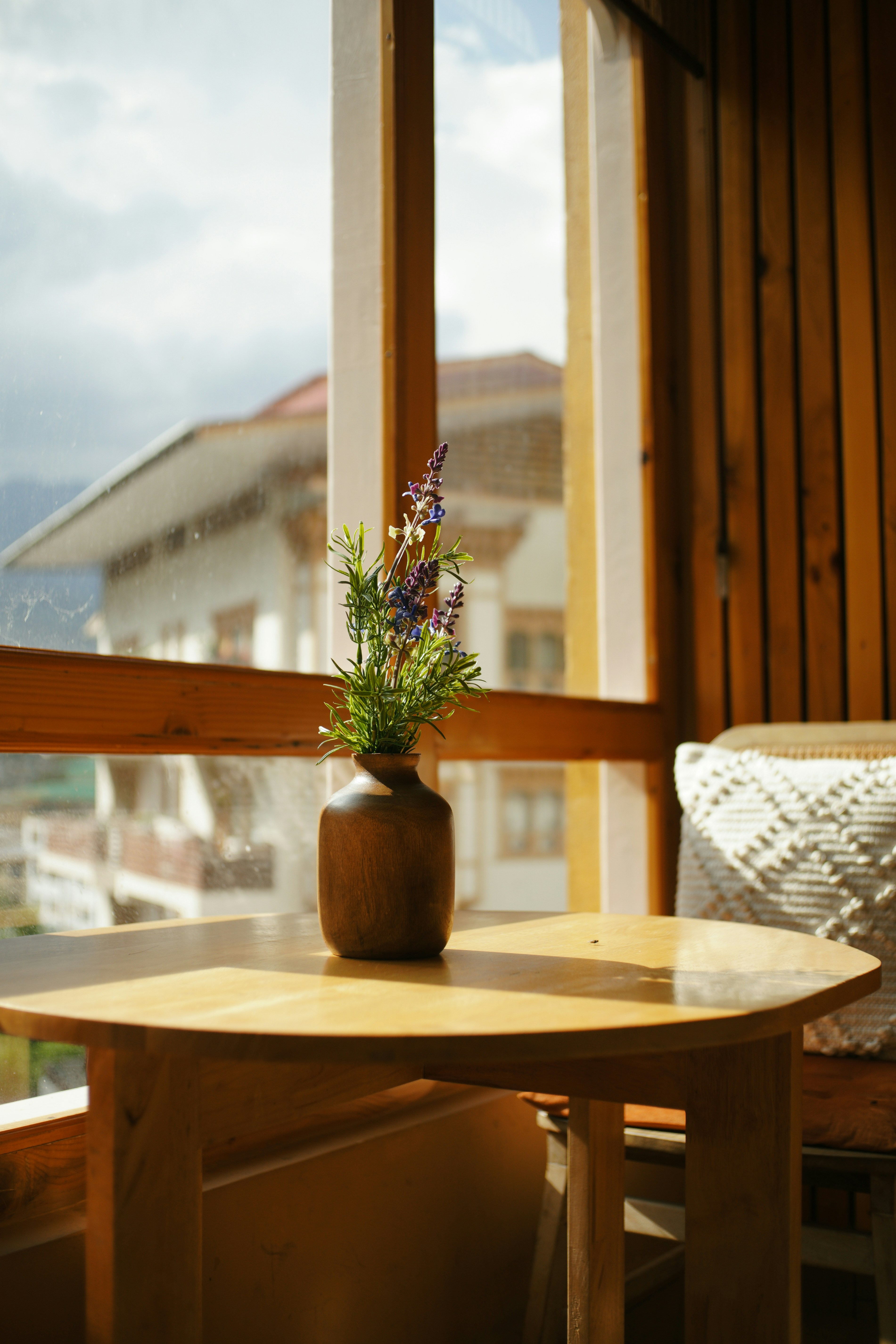 Sunlit Vase on a Wooden Table in a Cozy Corner