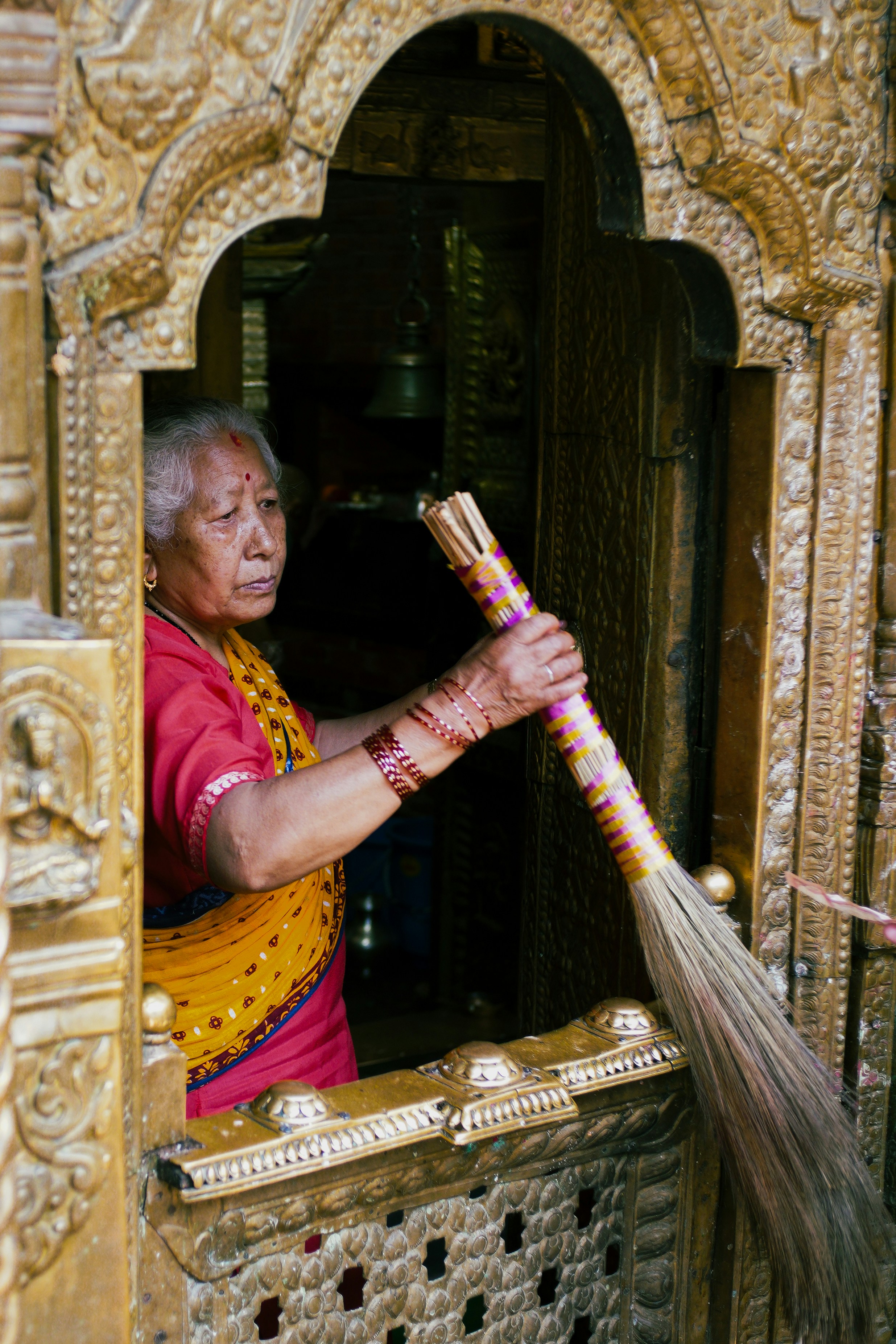 Swept into Focus: An Elderly Artisan at Work with a Hand-Broom Gate