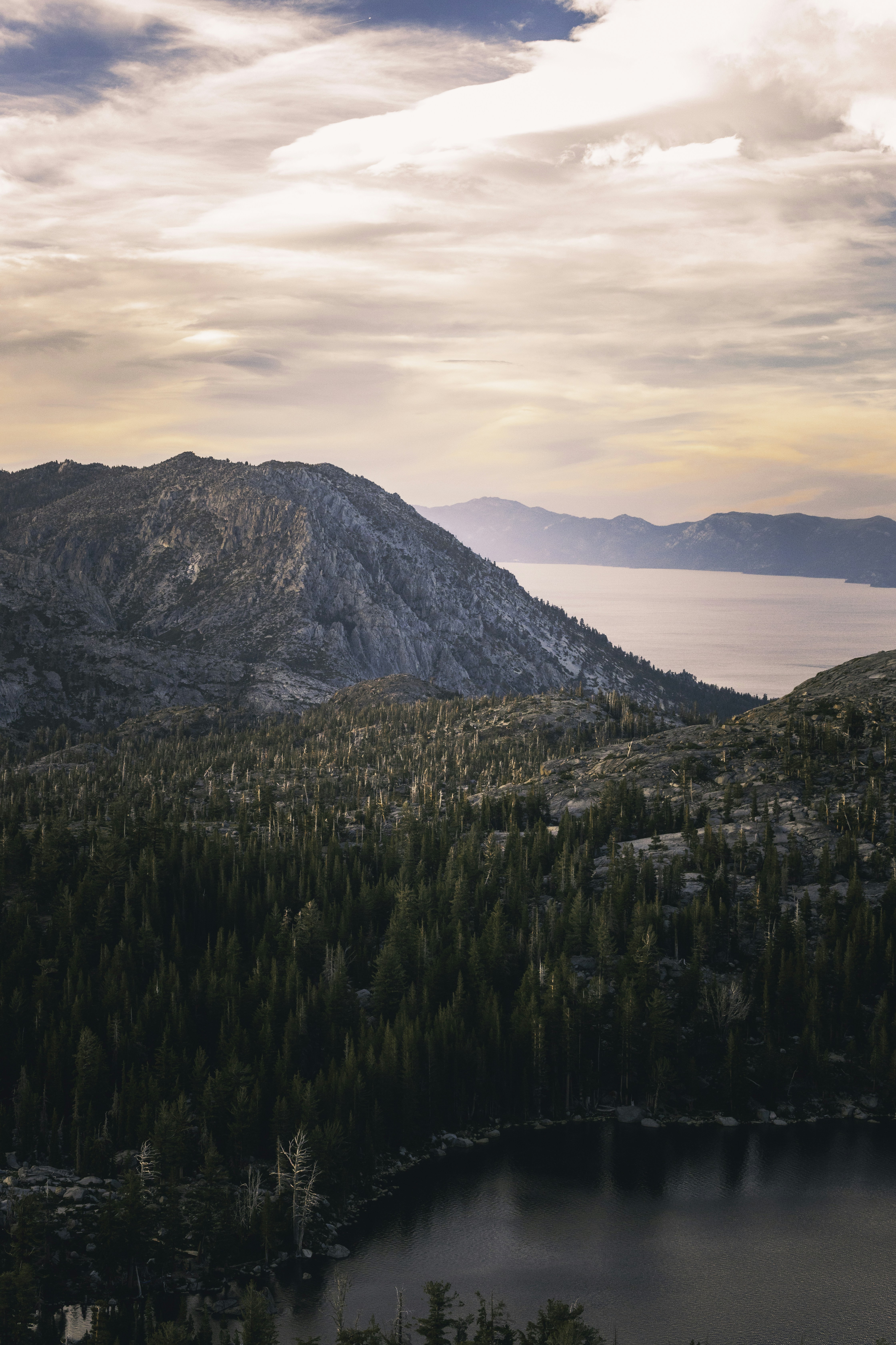 Sunset Over Lake Enclave: A Majestic Ridge Beneath Peach-Hued Skies