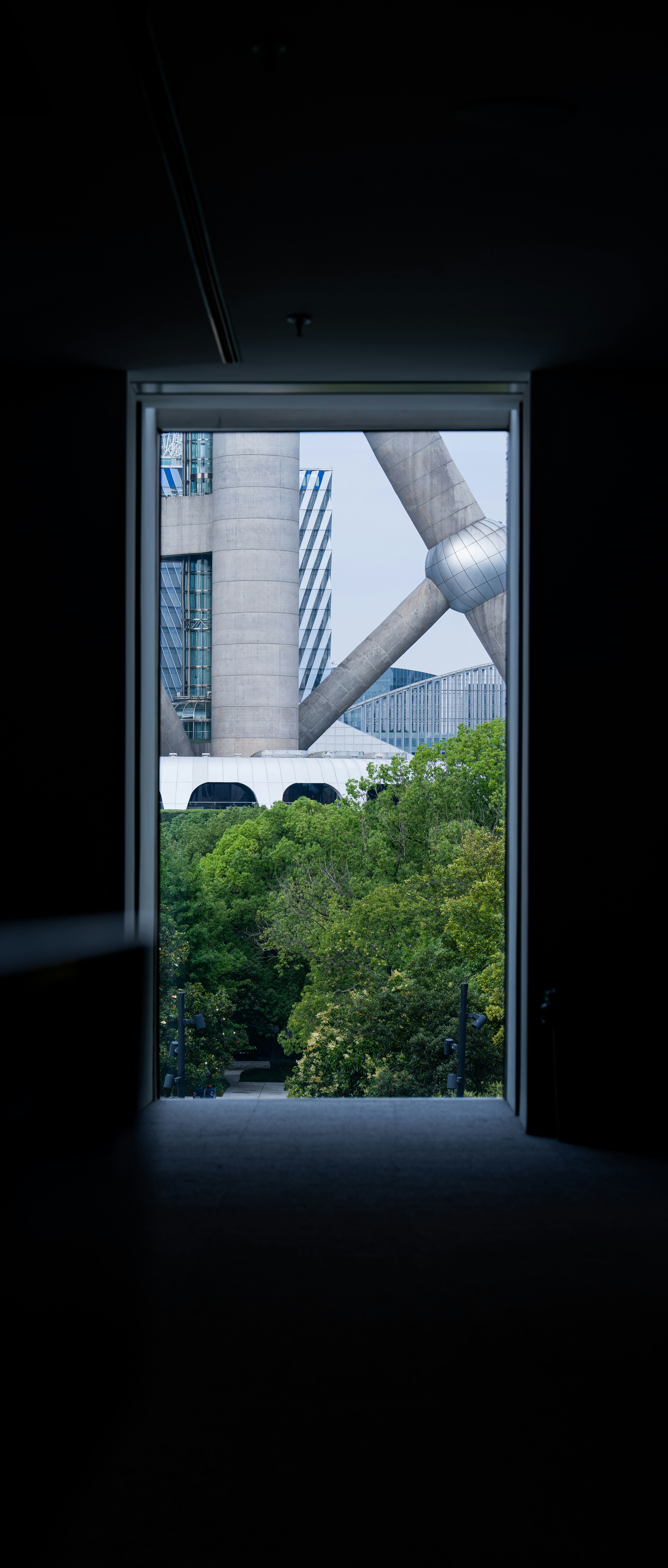 Threshold to the City: Concrete Arches framed by green daylight
