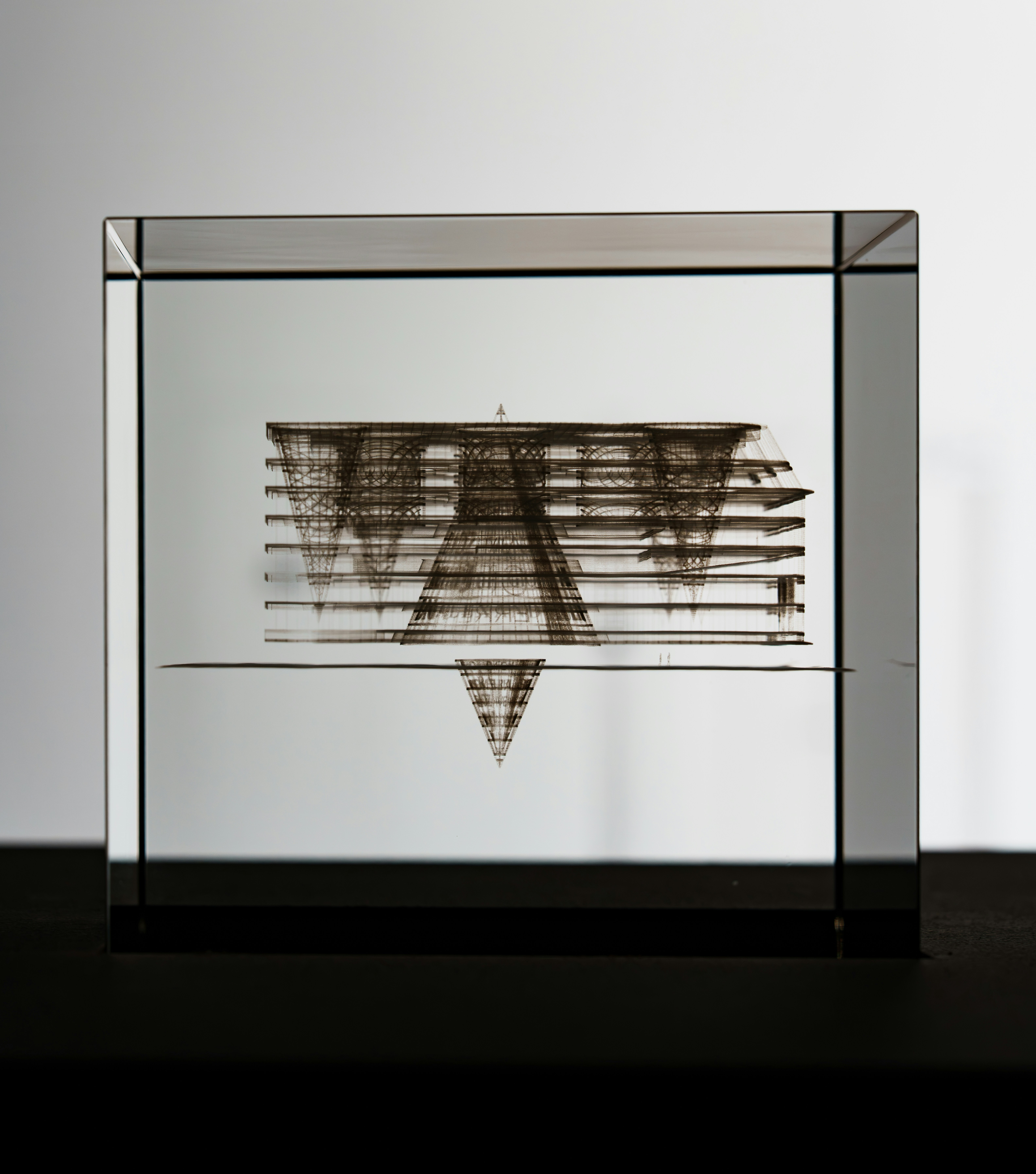 Illuminated Glass Glyph: A Geometric Prism of Shadows
