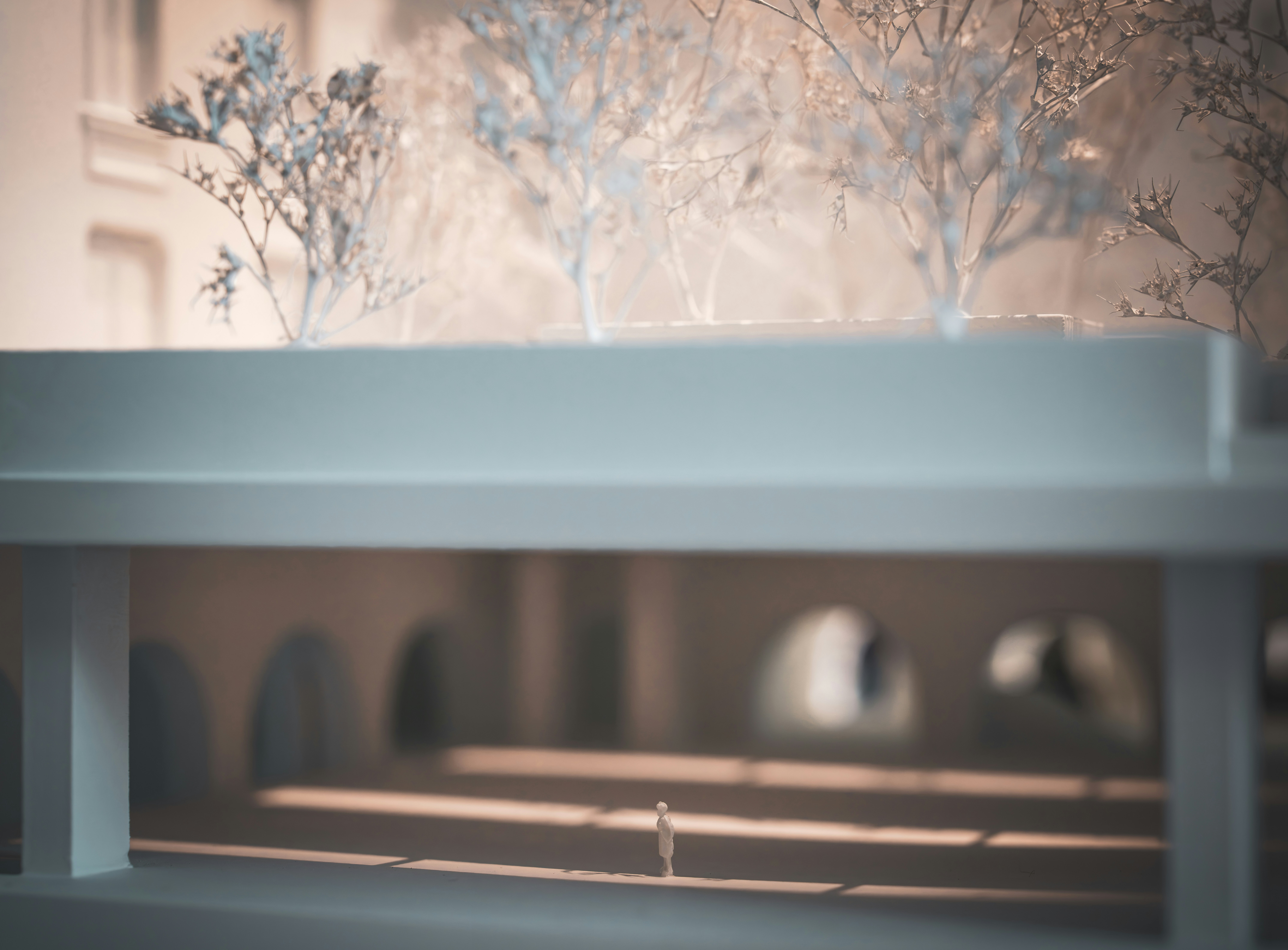Minimal bench under a cool canopy: distant courtyard lines converge