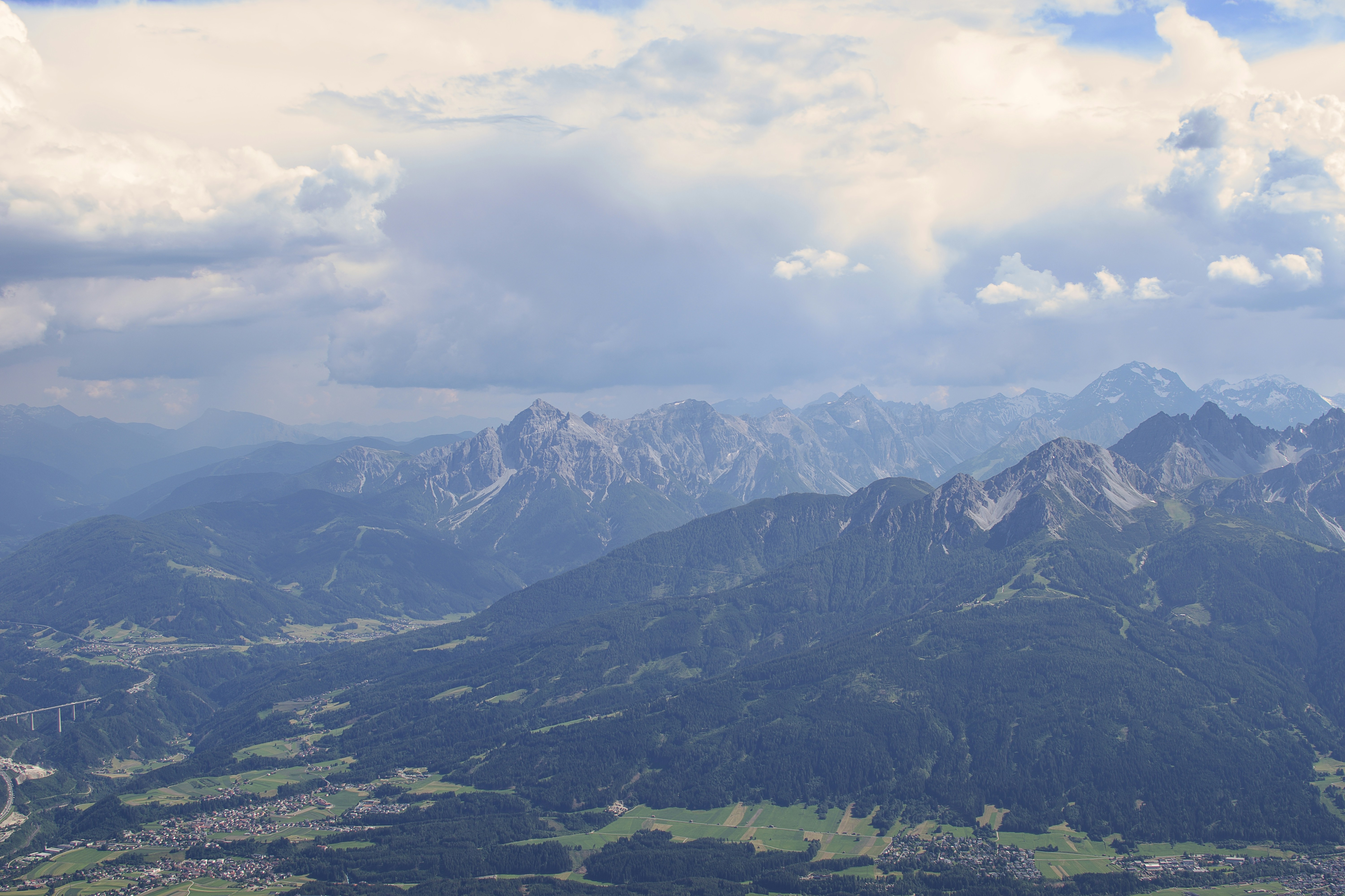 Aerial Vistas: Alpine Ridge Descends into Valley Green