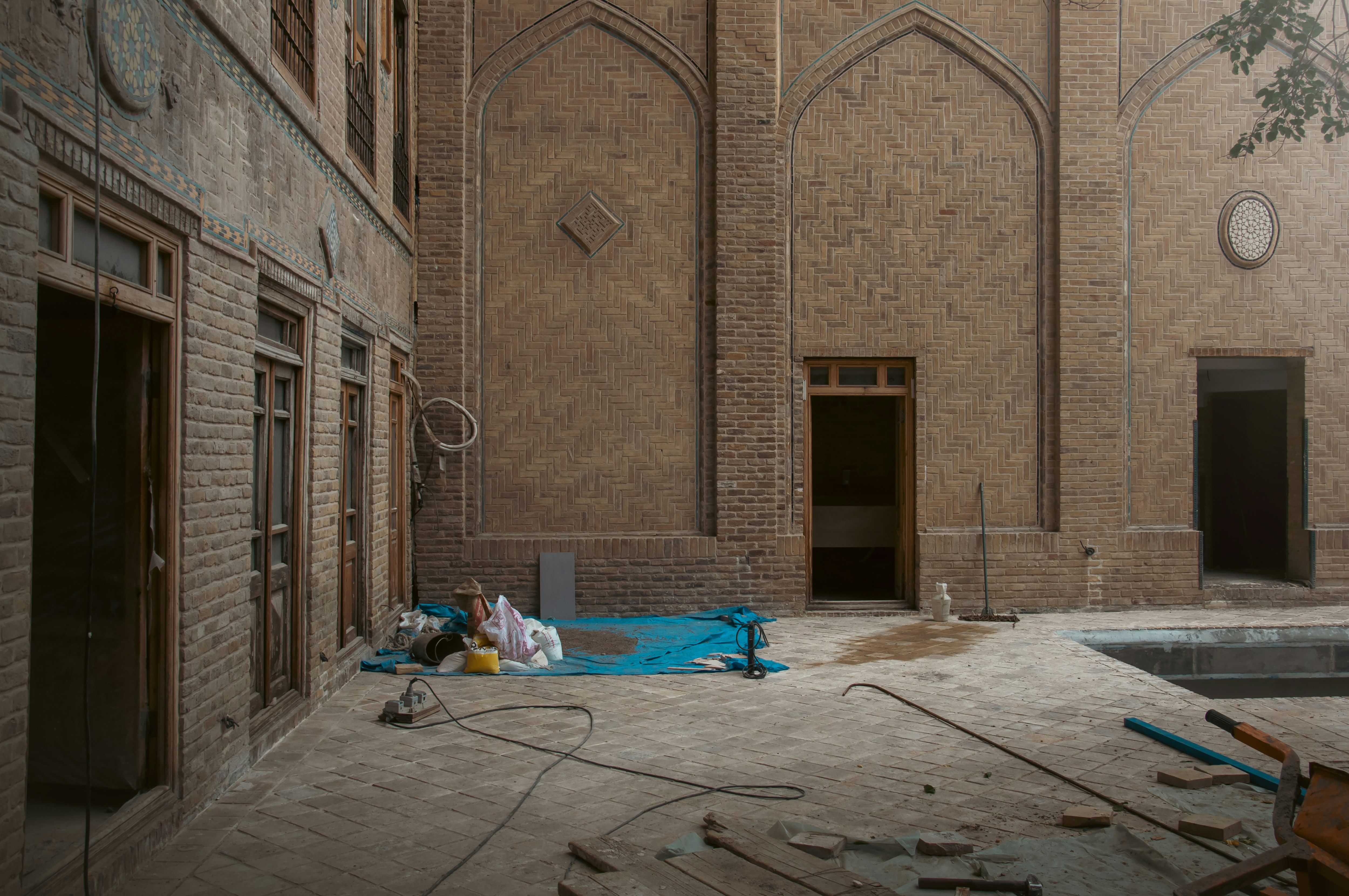An Abandoned Courtyard Beneath Brick Arches