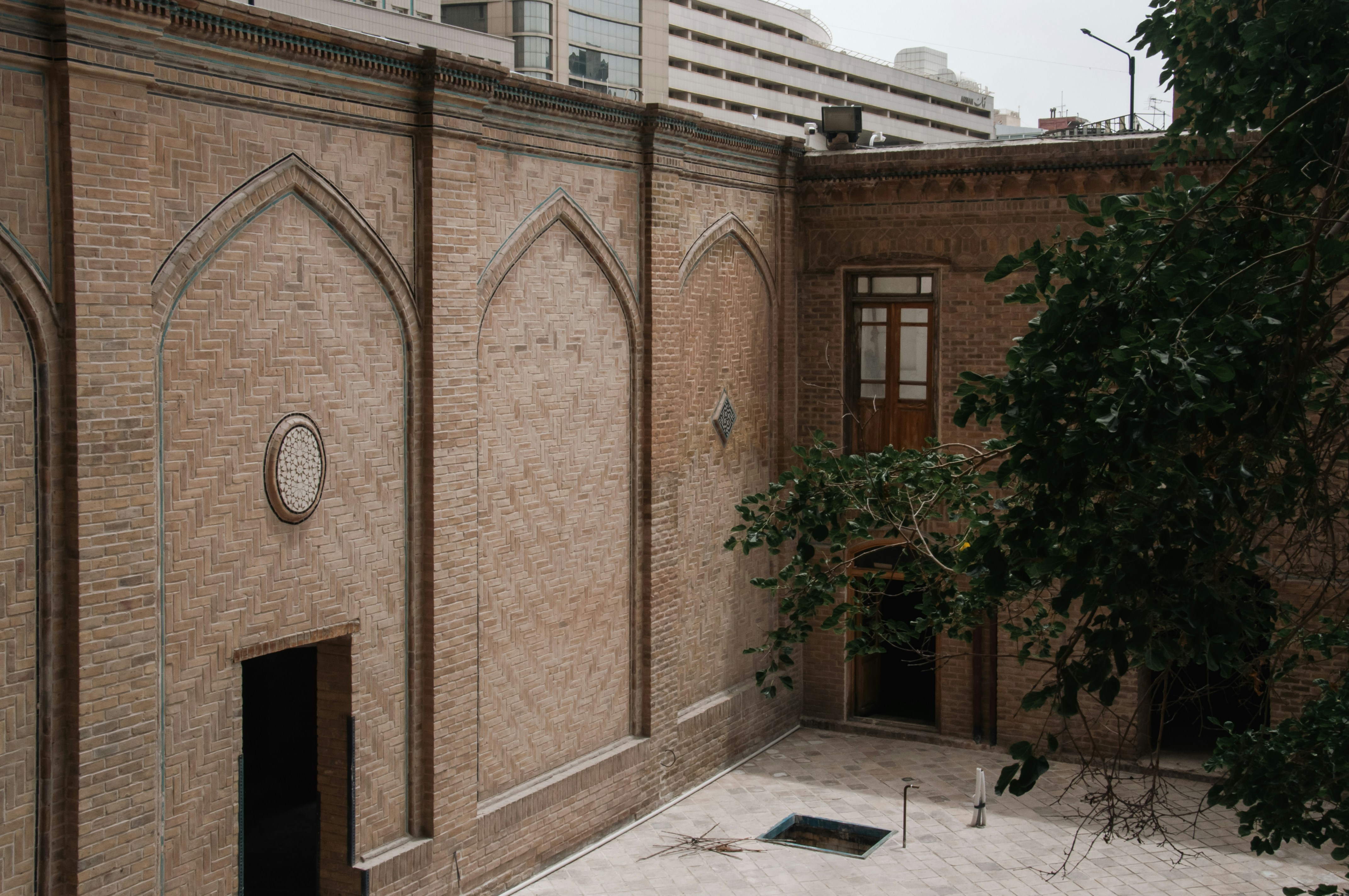 Brick Archway Courtyard with Overhanging Foliage