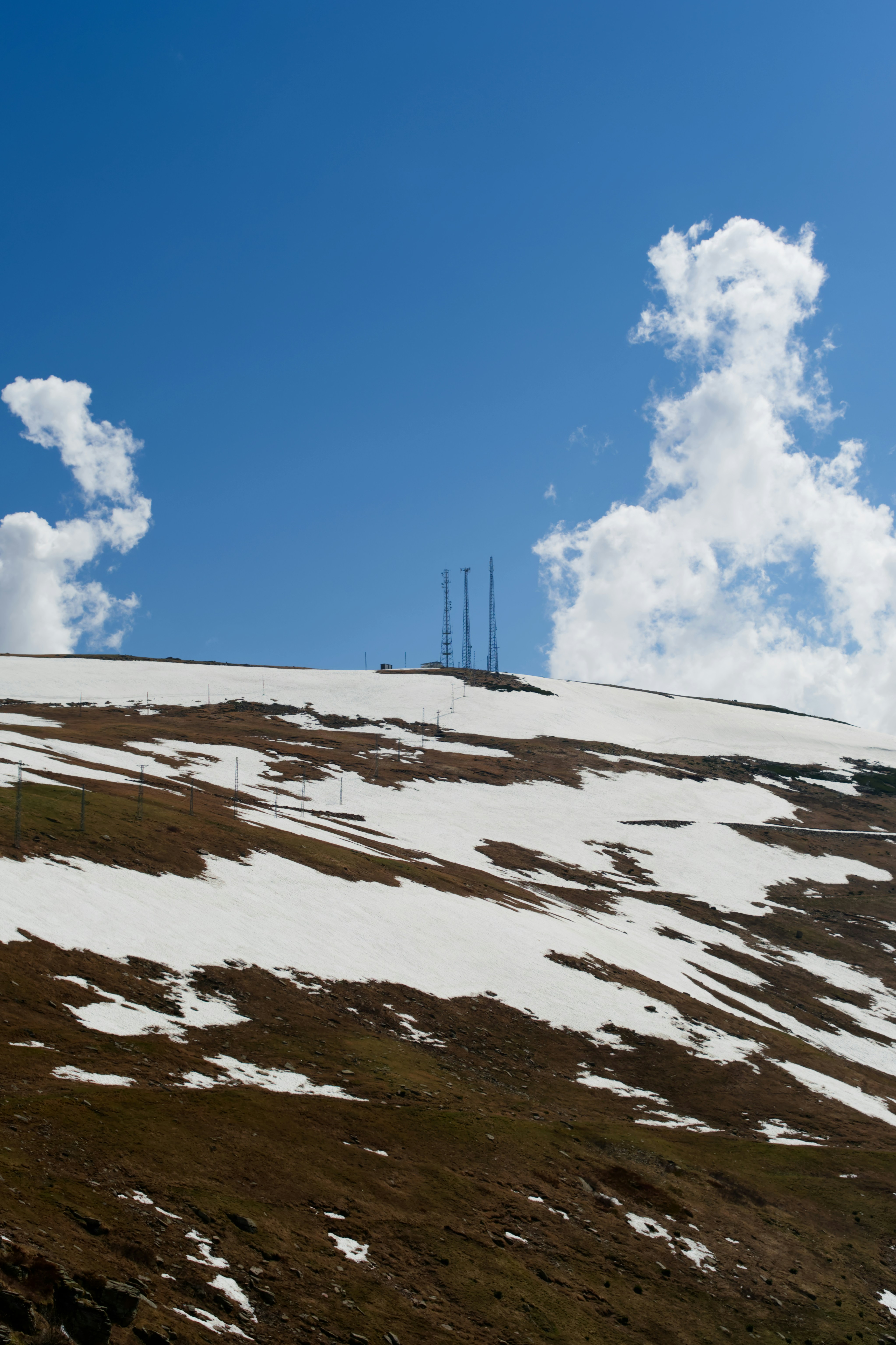 Snow‑kissed ridge under a tall Colorado blue