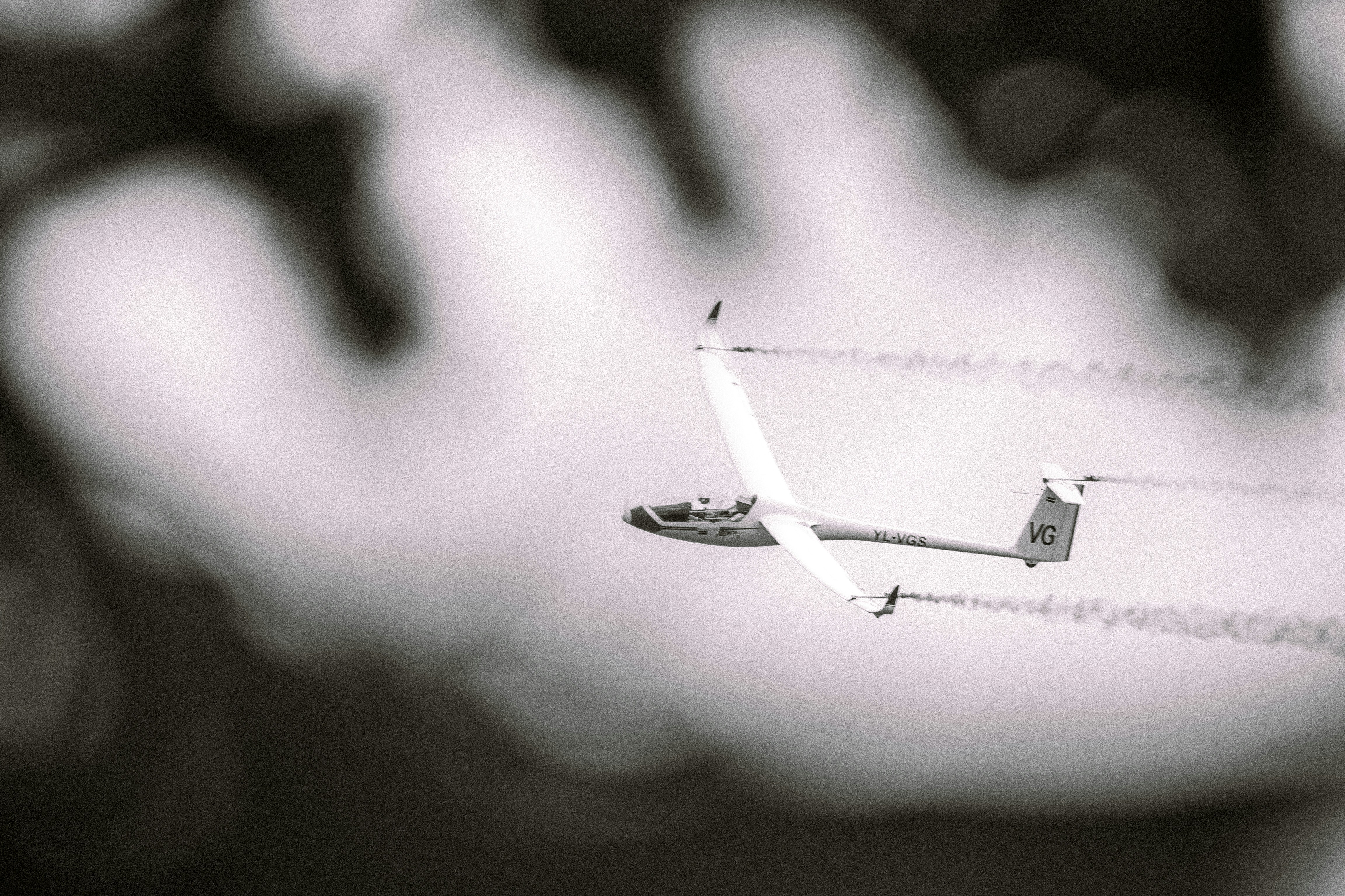 Winged glider slicing through a sepia sky