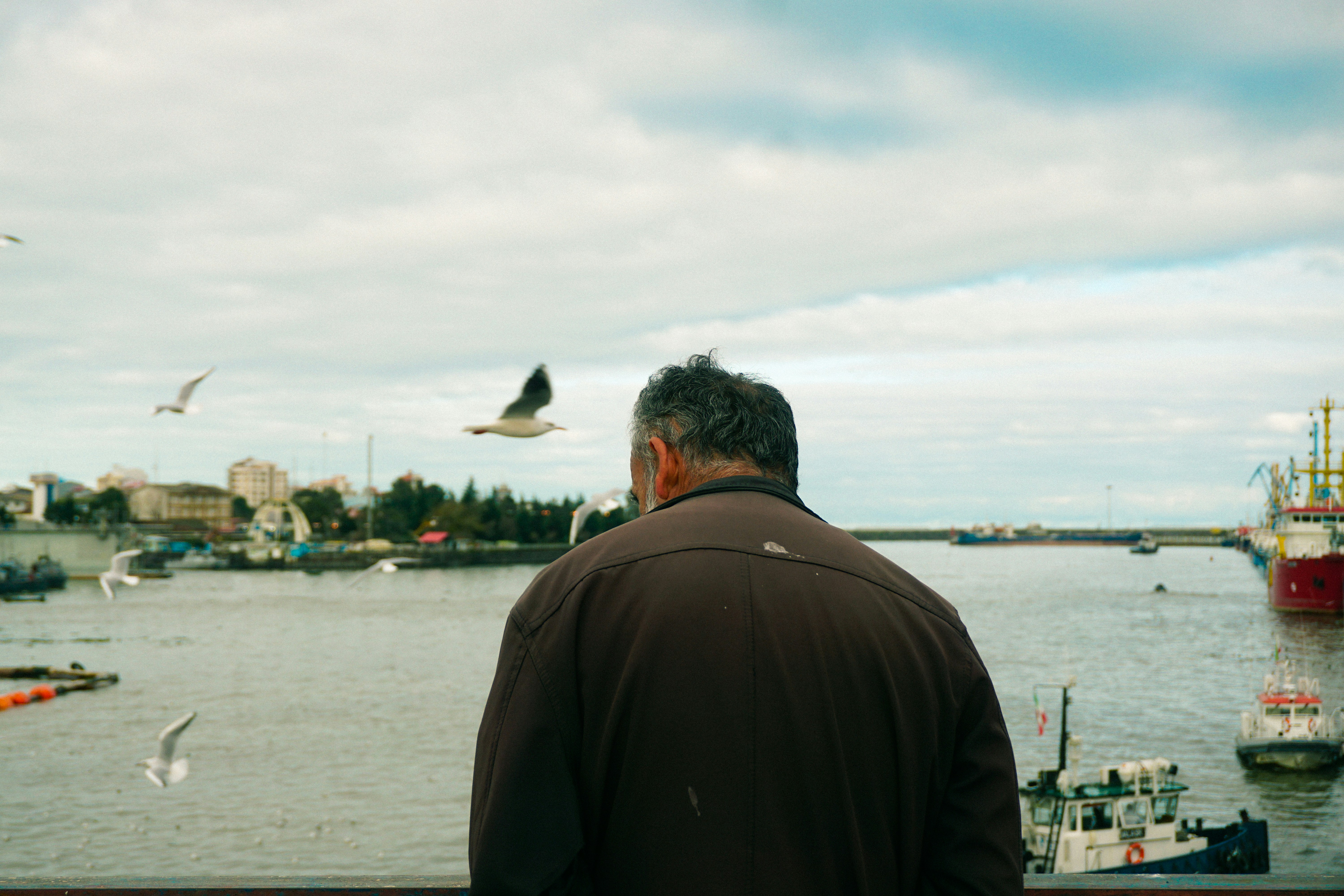Back to the Harbor: The Secluded Figure Beneath an Expansive Sky