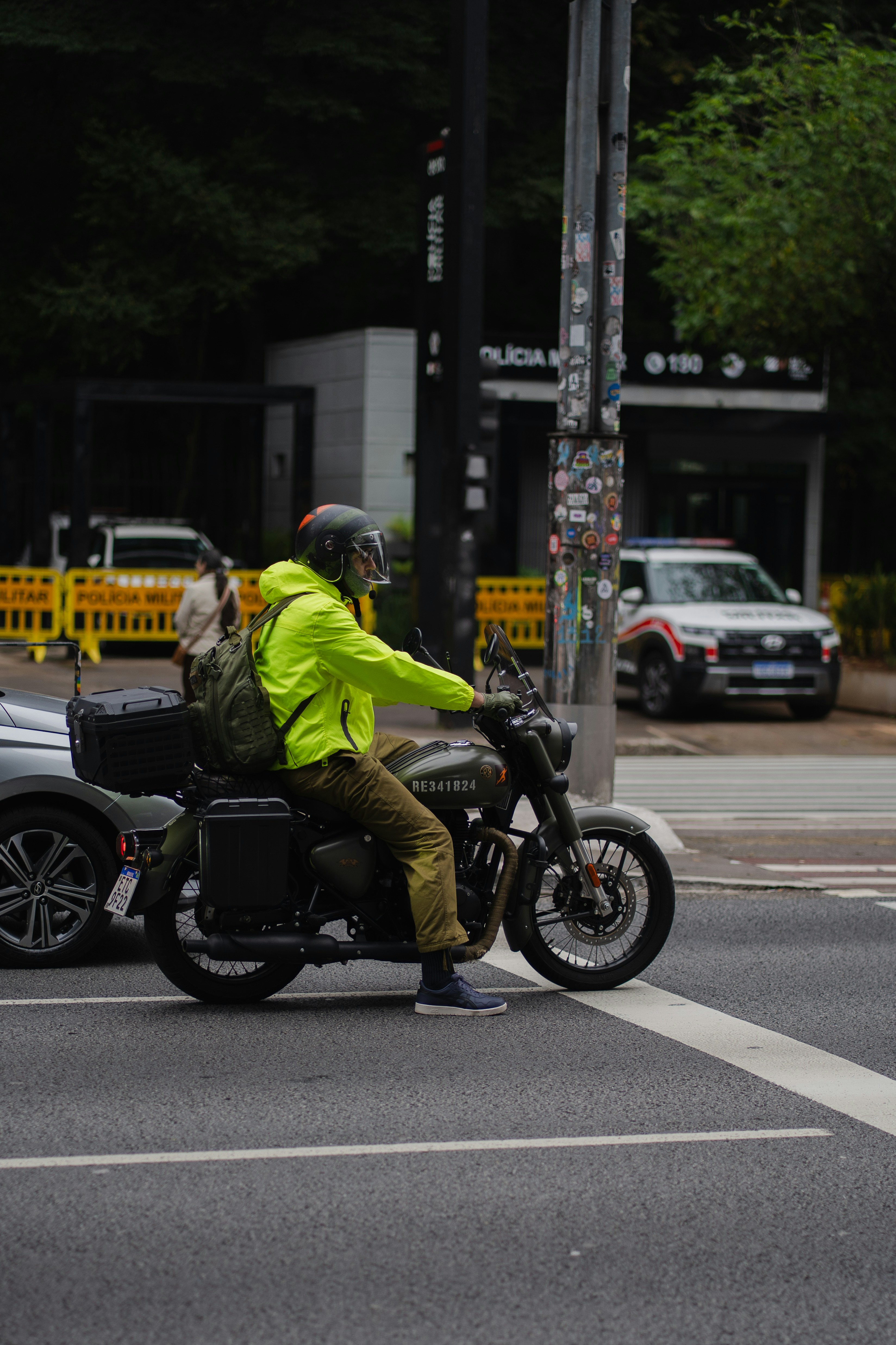 Neon Jacket on the Street: A Moto Rider at a City Crosswalk