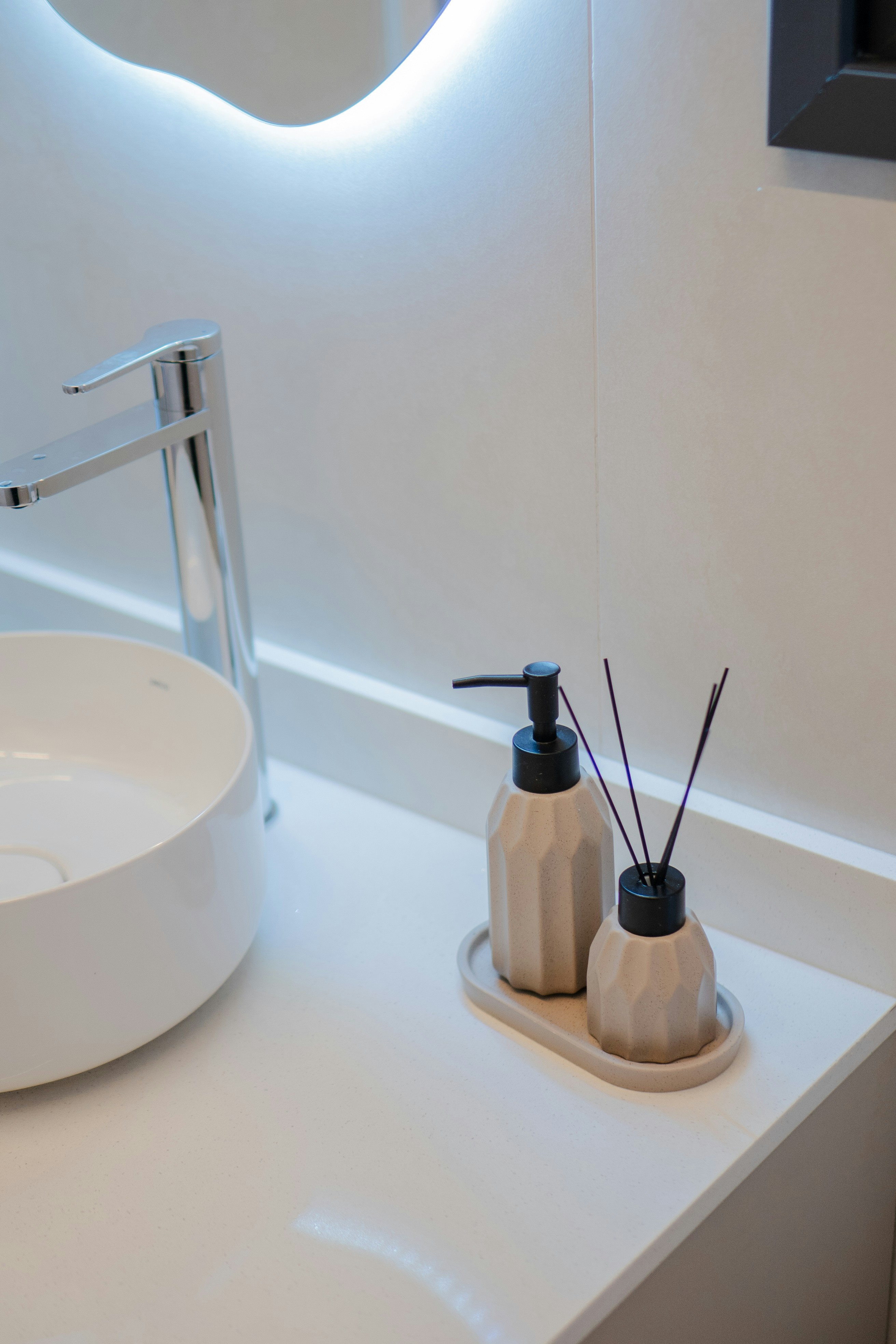 Minimalist bathroom countertop with geometric bottles