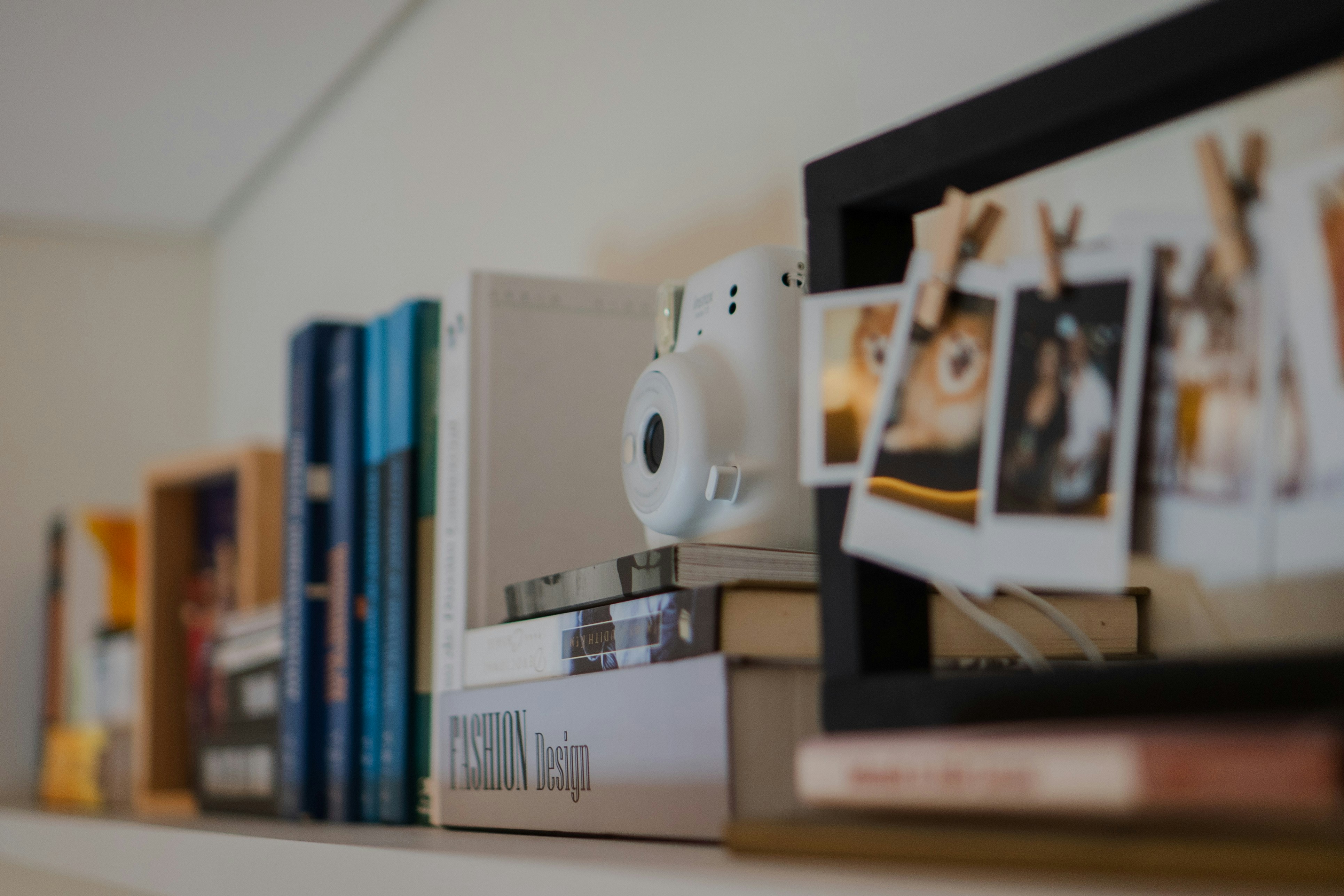 Retro Polaroid Moments: A Compact Camera Amid Books and Frames