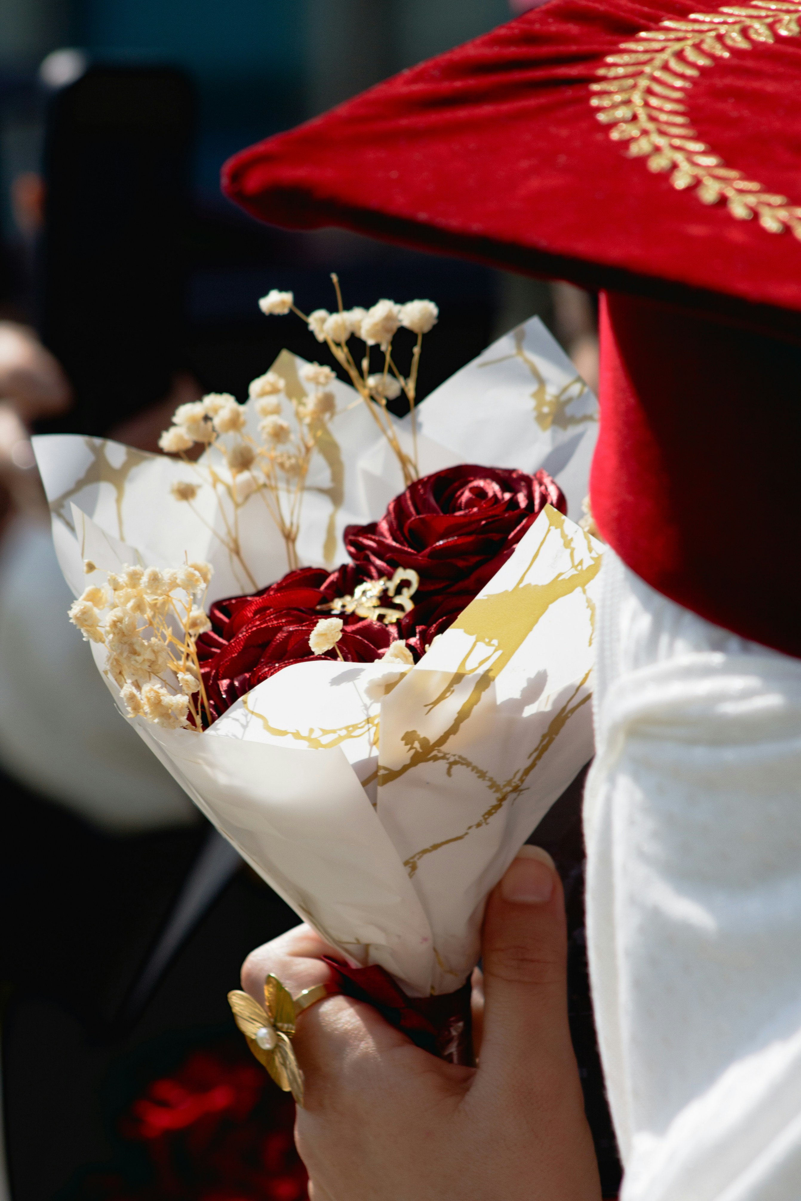 Crimson Bouquet Close-Up at the Edge of Ceremony