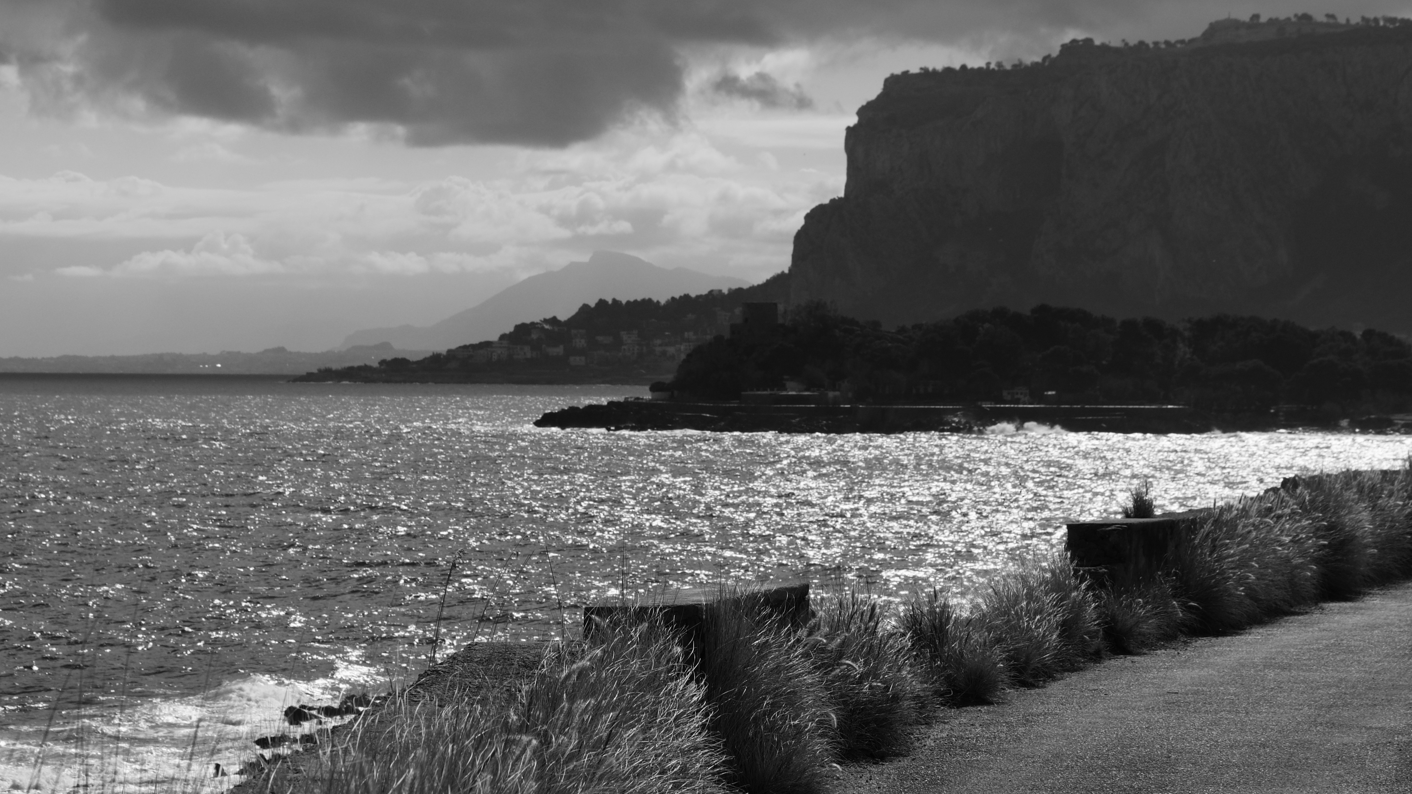 Harbor Roadside Silhouette: A Granite Cliff over Calm Waters