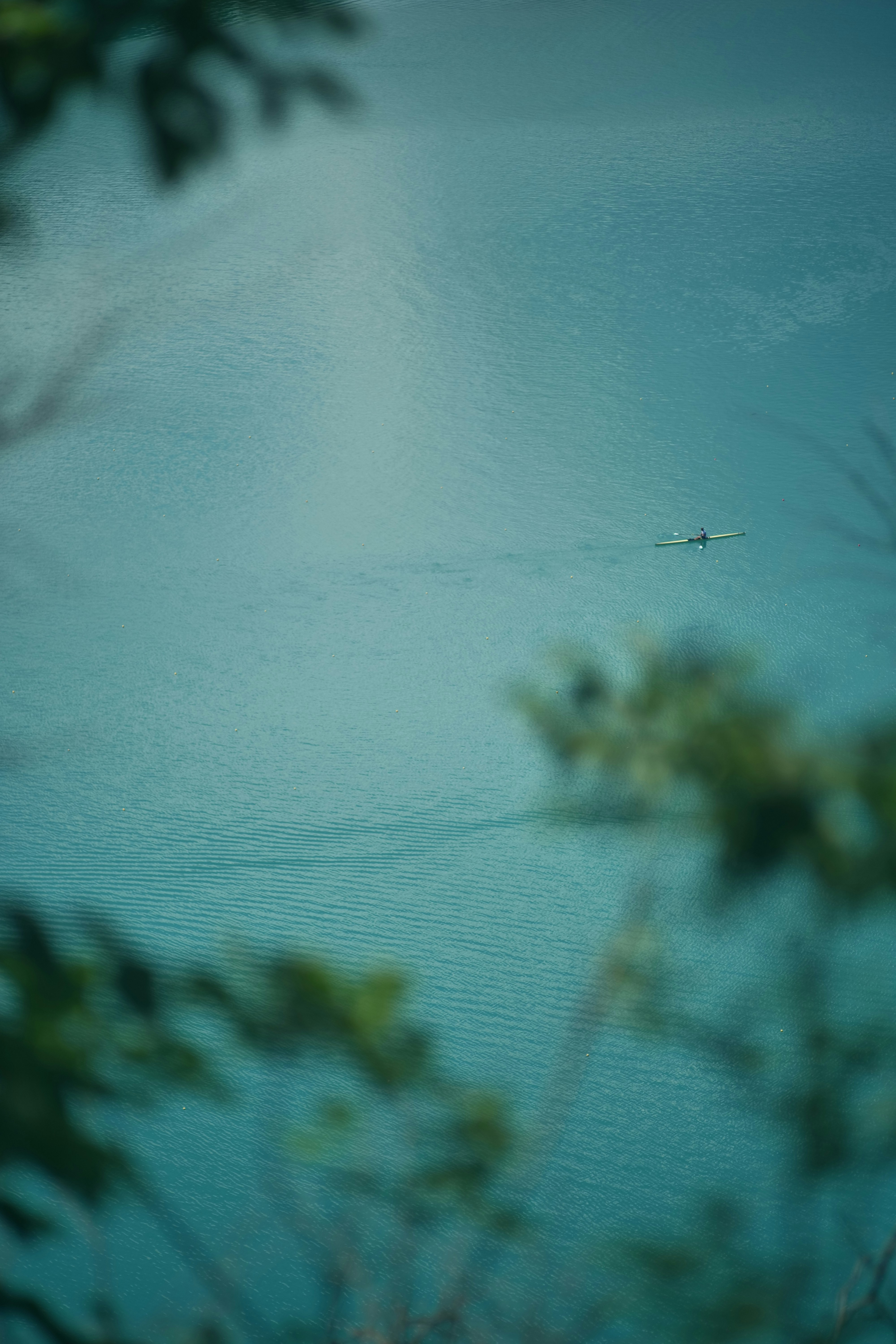 Serene Kayak Drift Across A Turquoise Wake