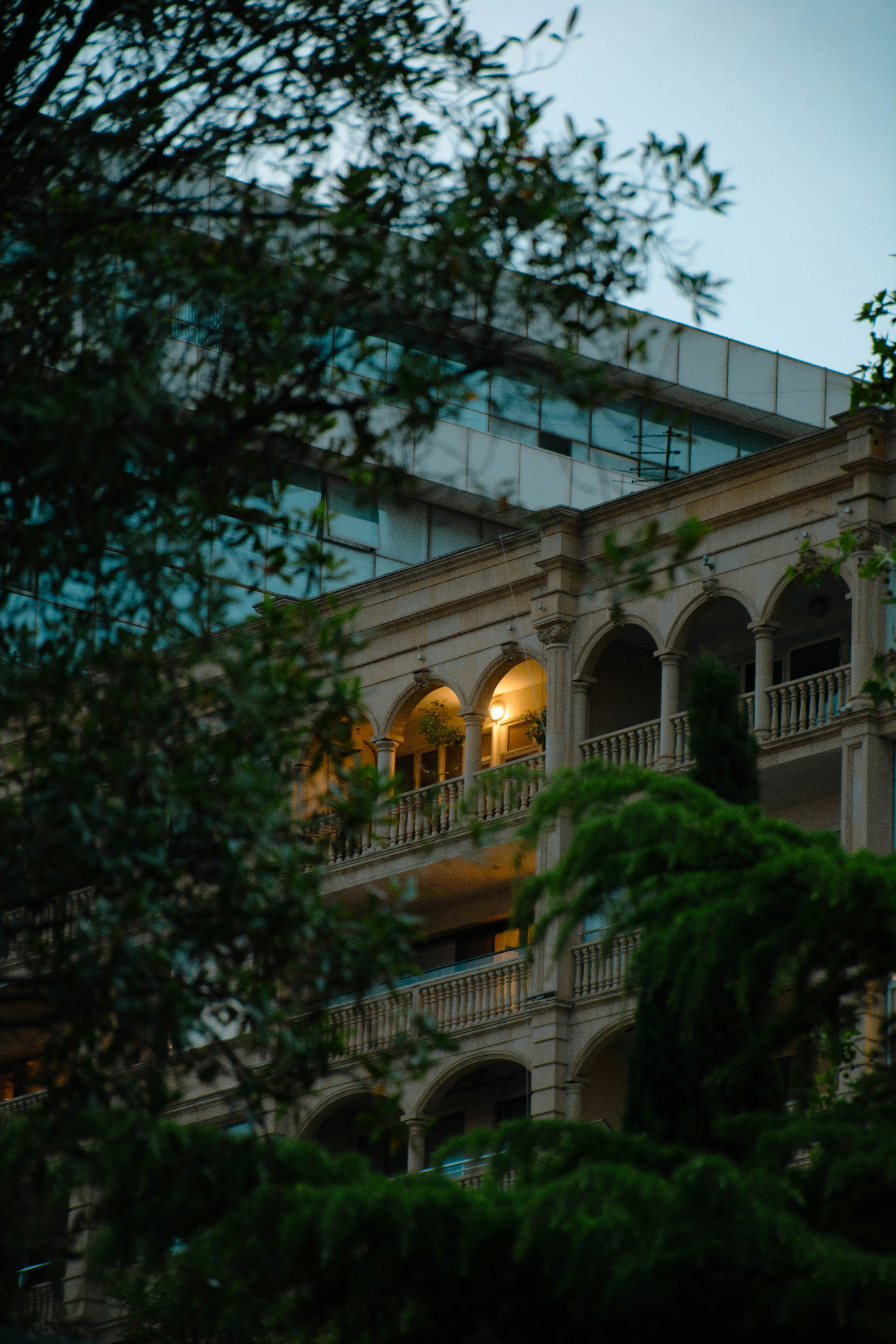 Arched Retreat: Warm Glow Amid Urban Courtyard Facades