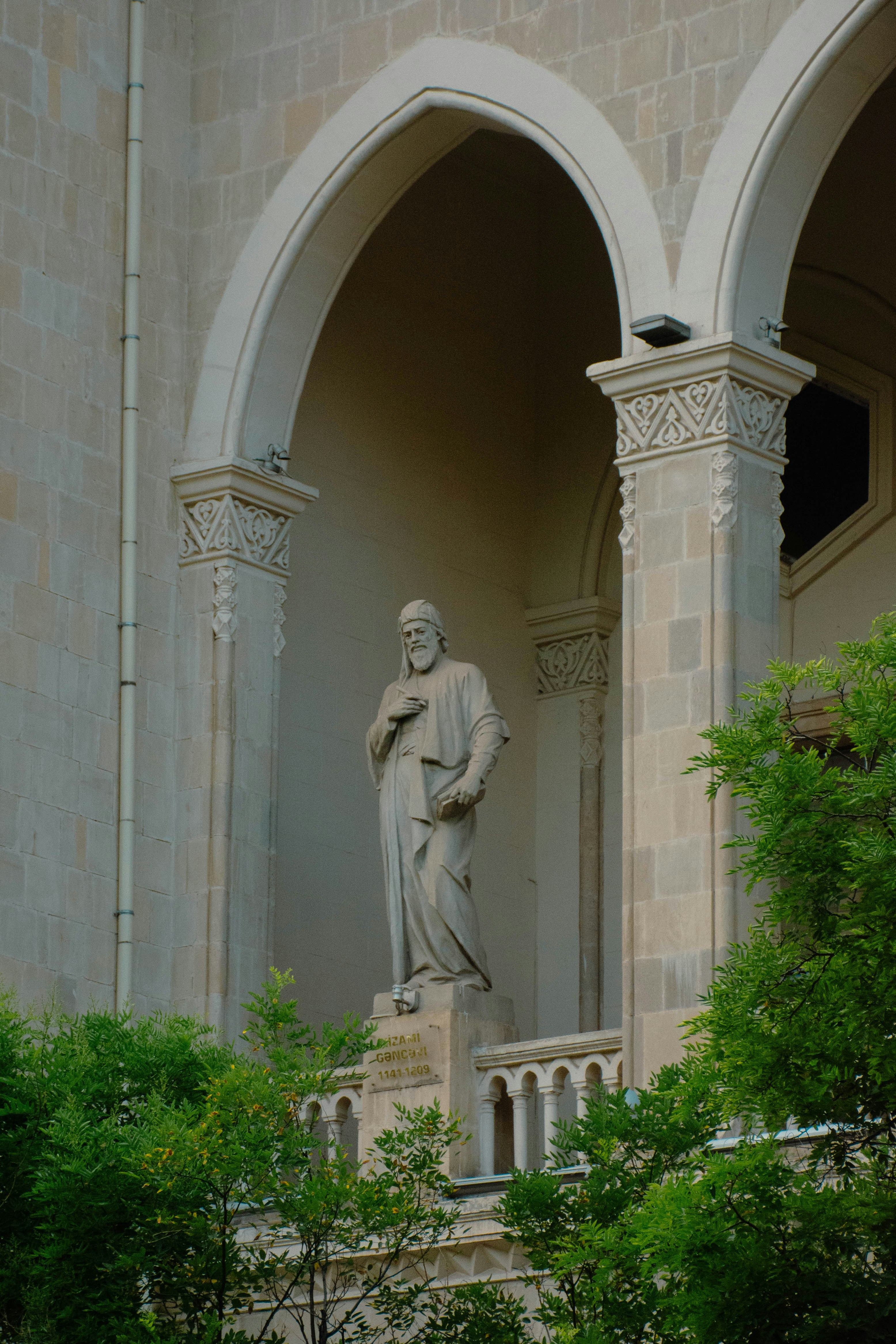 Statue Beneath Arched Colonnade: A Quiet Moment in stone