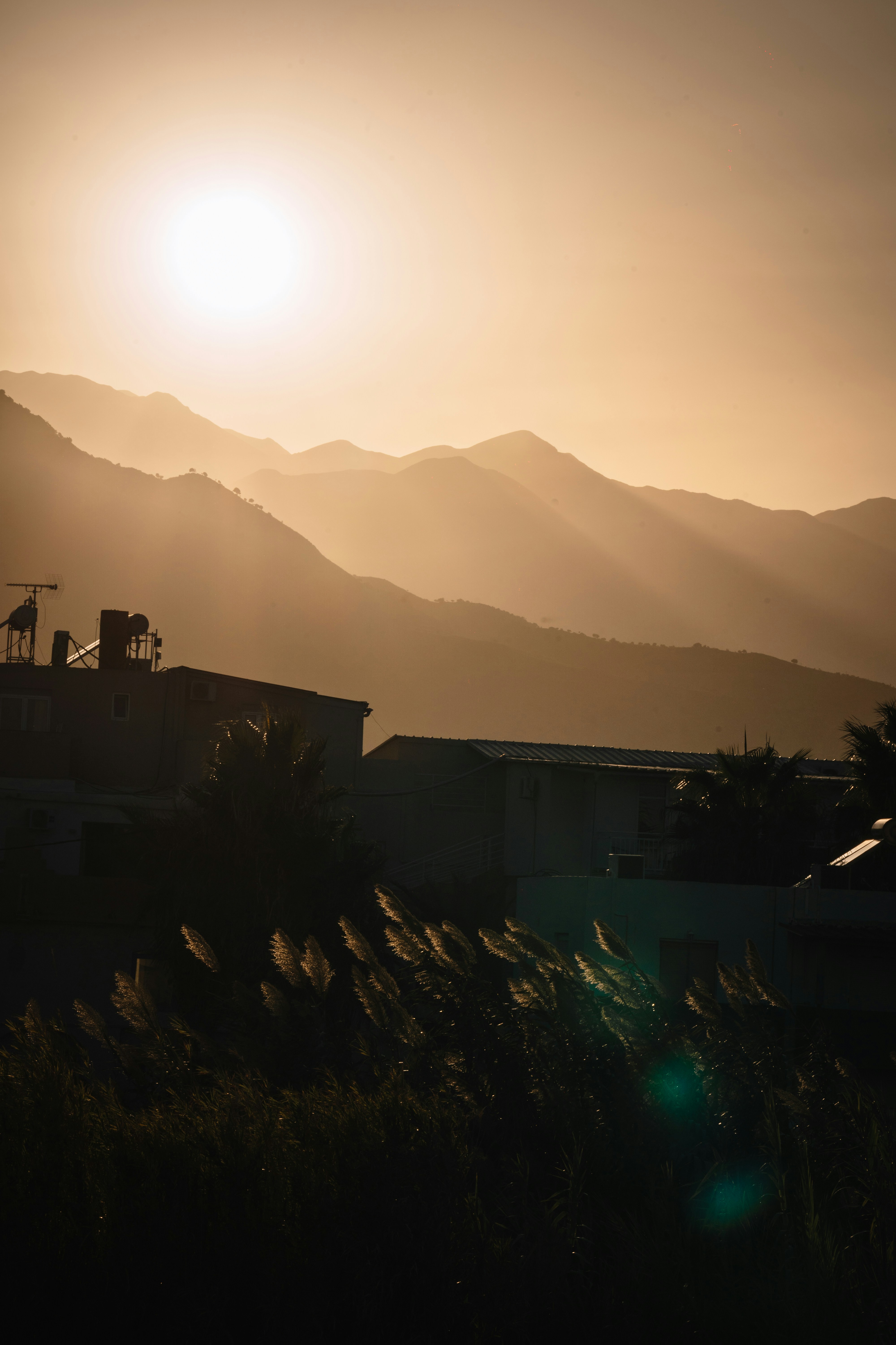 Golden Valleys at Dusk: A Silhouetted Horizon Above Quiet Homes