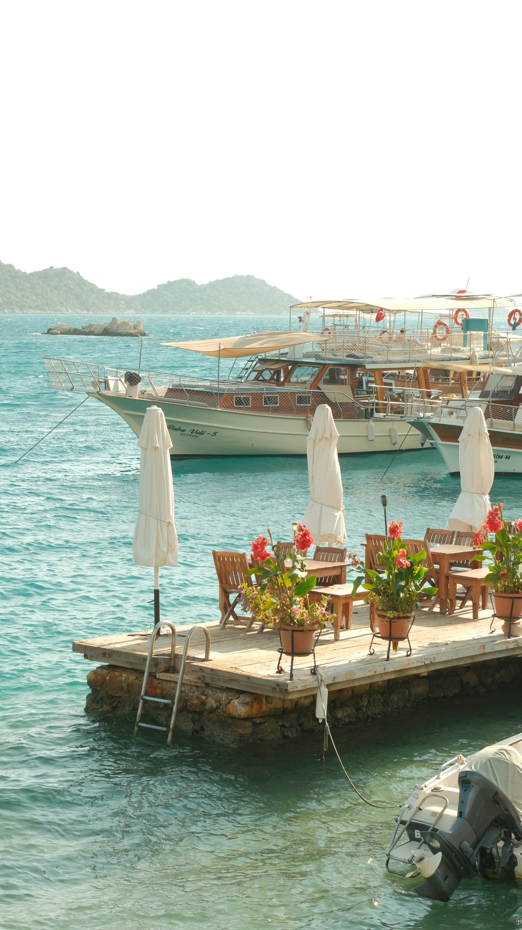 Harbor Annex: A Sunlit Terrace Overlooking Calm Turquoise Waters