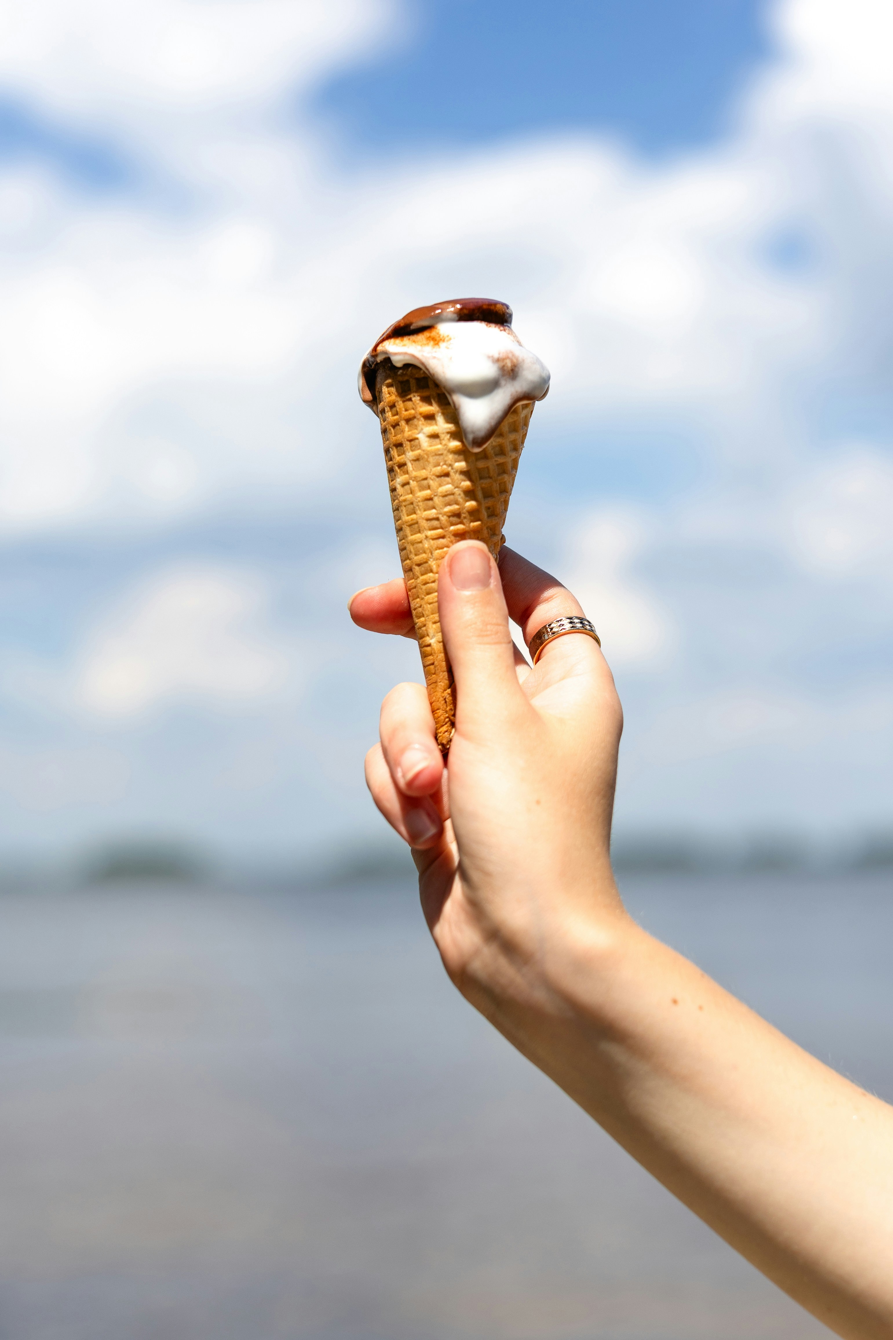 Handful of Summer: Ice Cream Cone Above the Blue Horizon