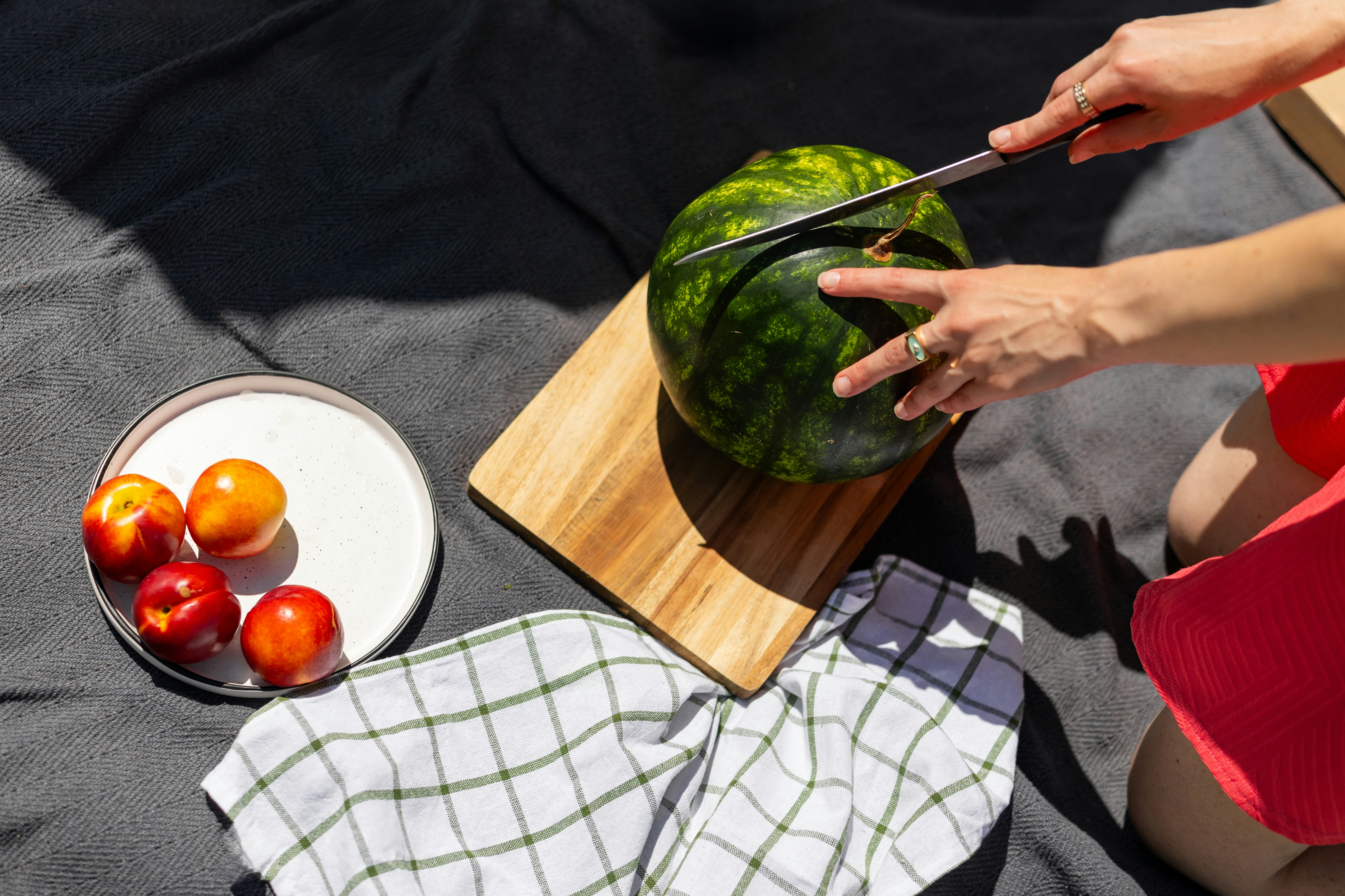 Hands at the Cutting Board: A Watermelon Preserved in Sunlit Prep