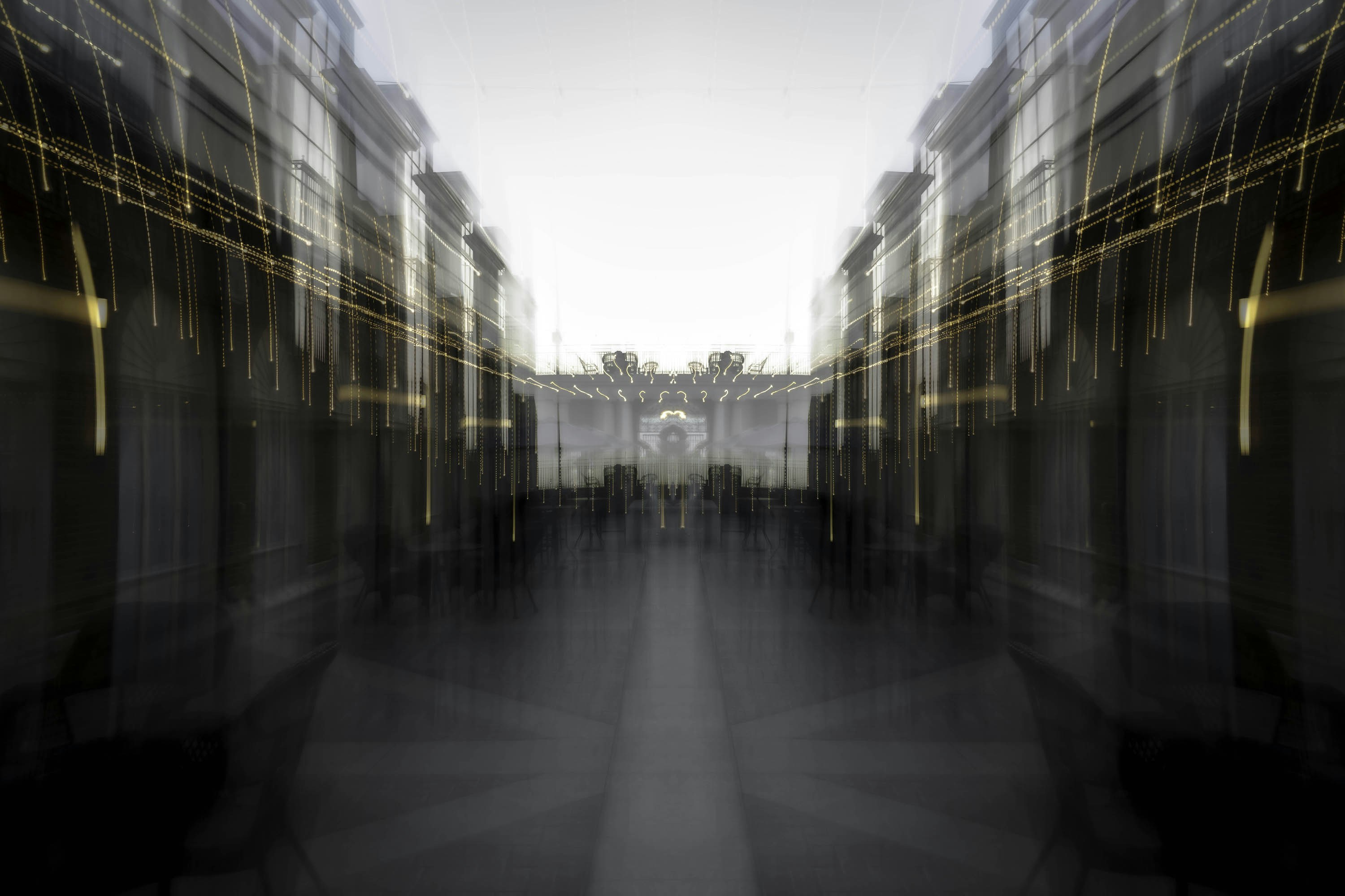 Blurred city corridor with mirrored perspective and warm vertical light accents; a long-exposure illusion capturing motion and symmetry. This is a photographic exploration rather than a logo, illustration, painting, or cartoon.