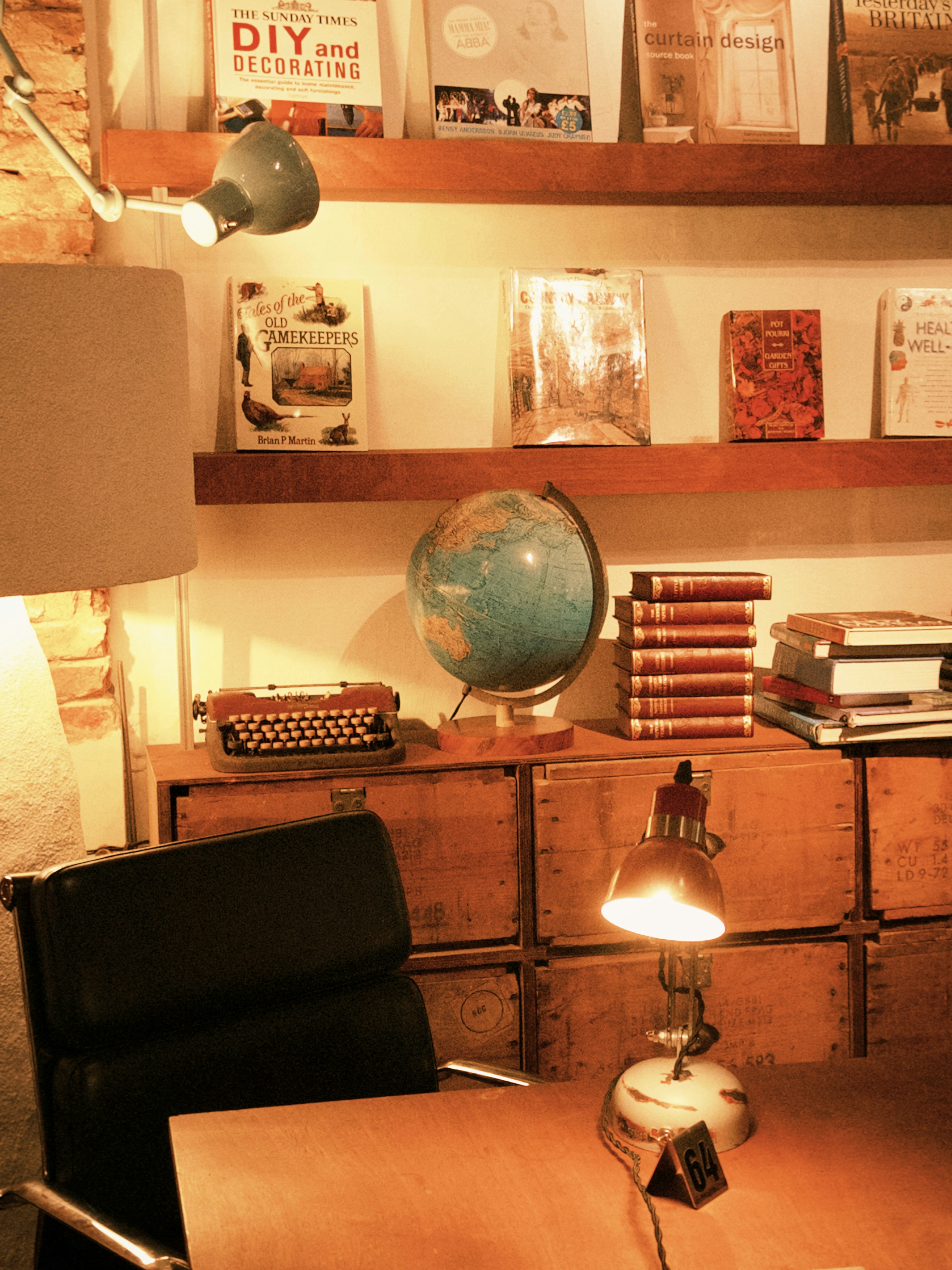 Warm Studio Nook: Globe, Typewriter, and Desk Lamp