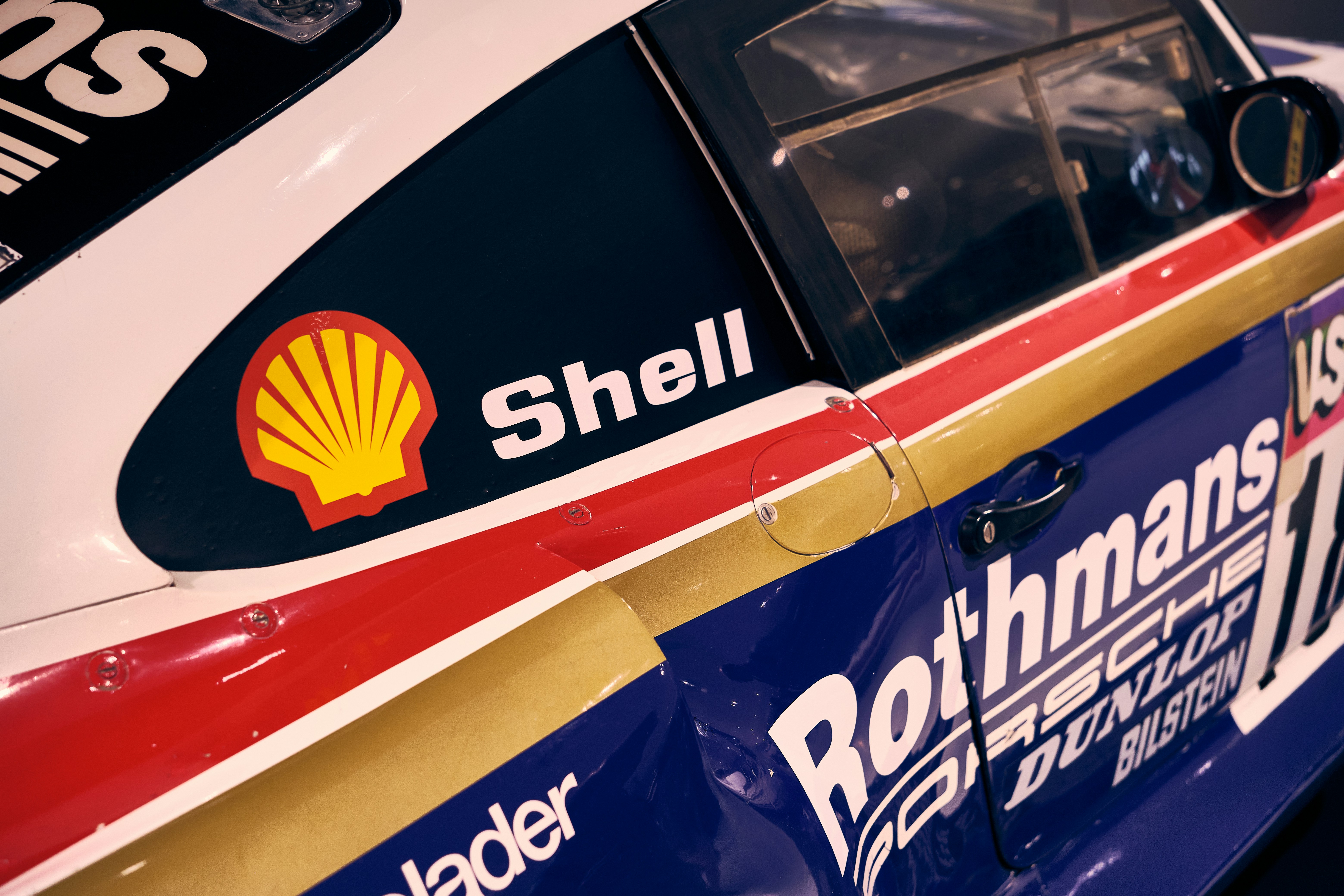 Shell-liveryed silhouette: a race car's side paneling and branding at speed