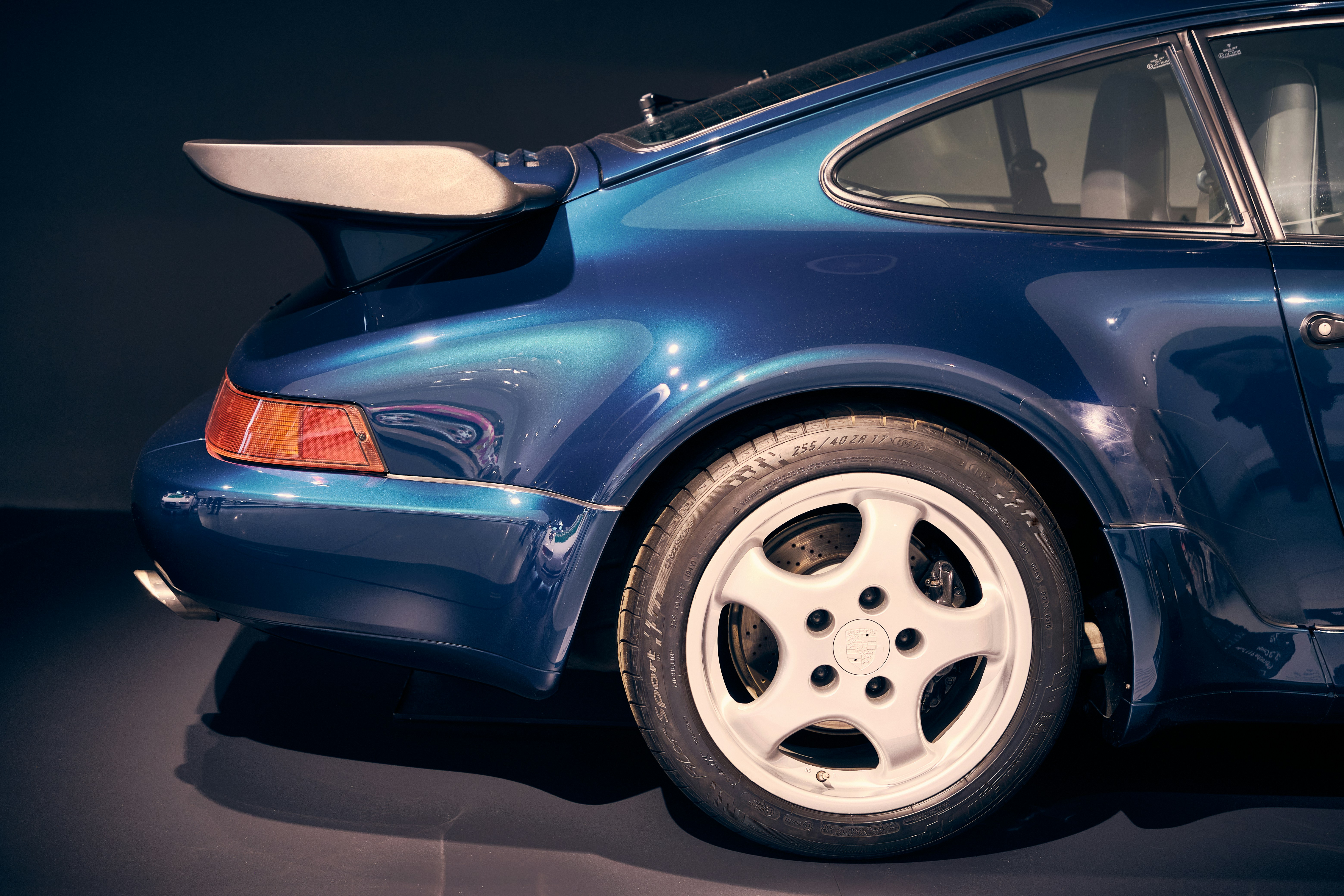 Blue Porsche Aesthetics: A twilight rear-quarter in motion of curves and gloss
