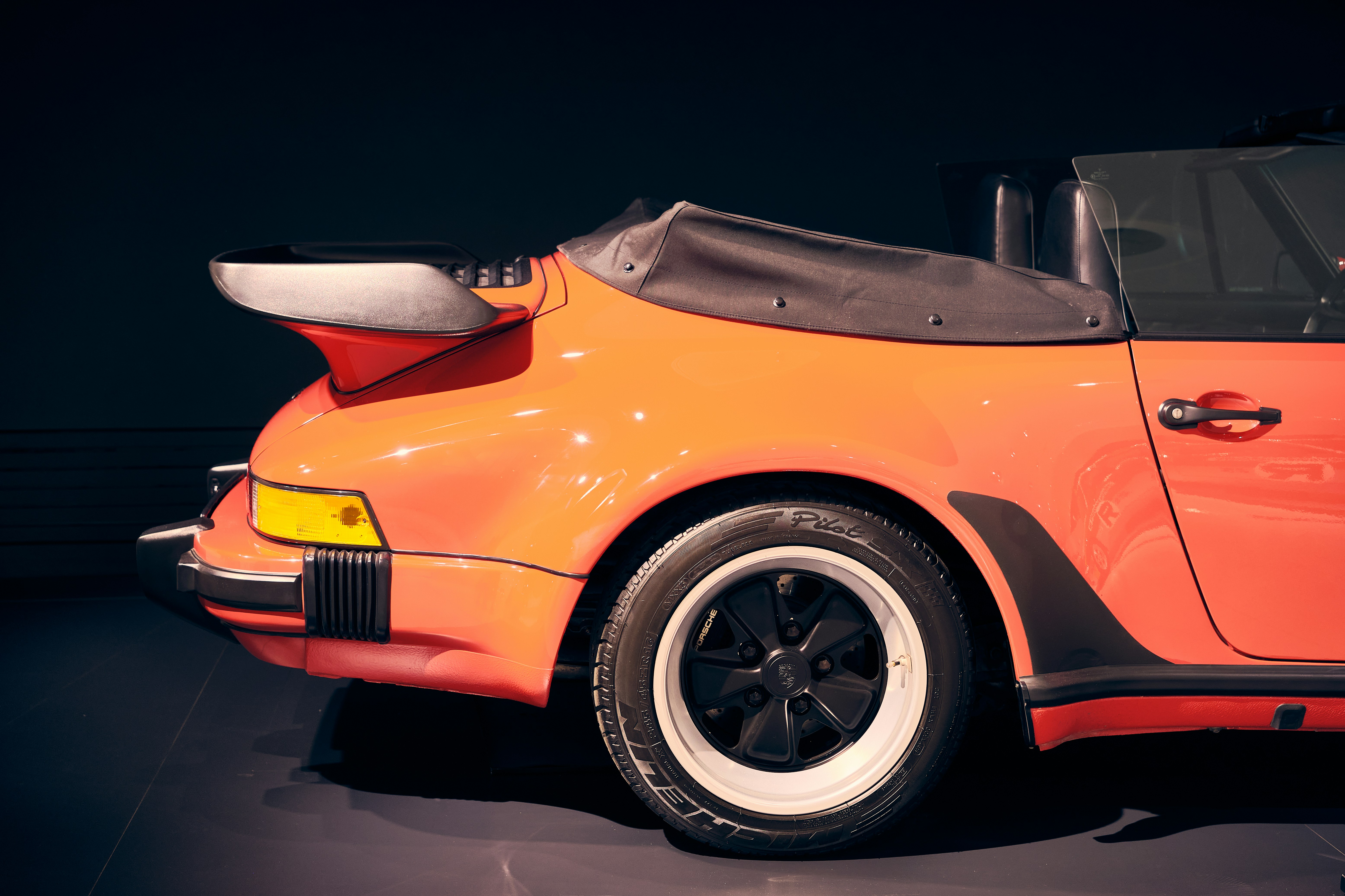 Orange Porsche: The Curved Silhouette and Bold Rear Wing