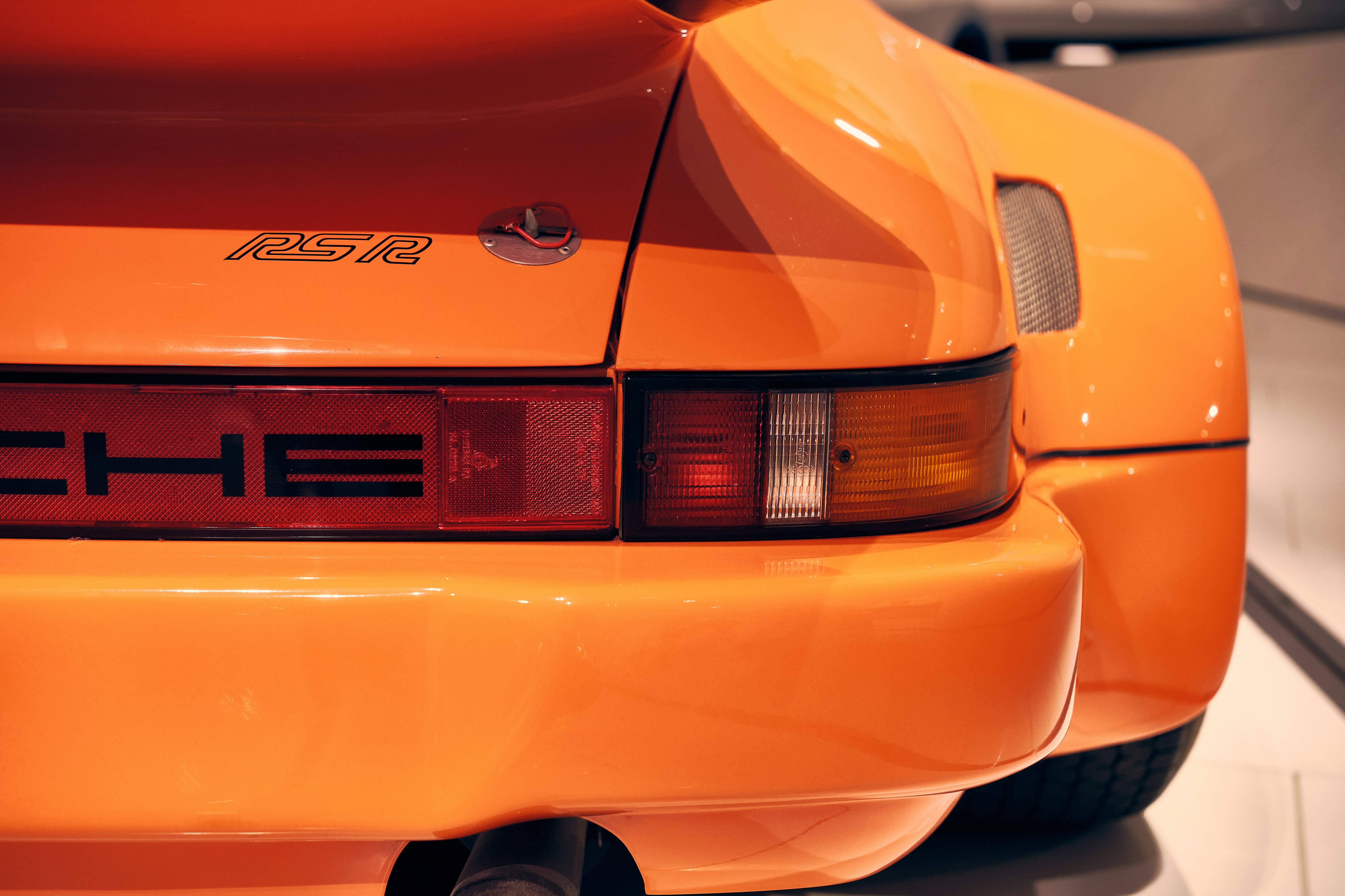 Orange Porsche RS2 Tail: A Close-Up of the Parked Icon