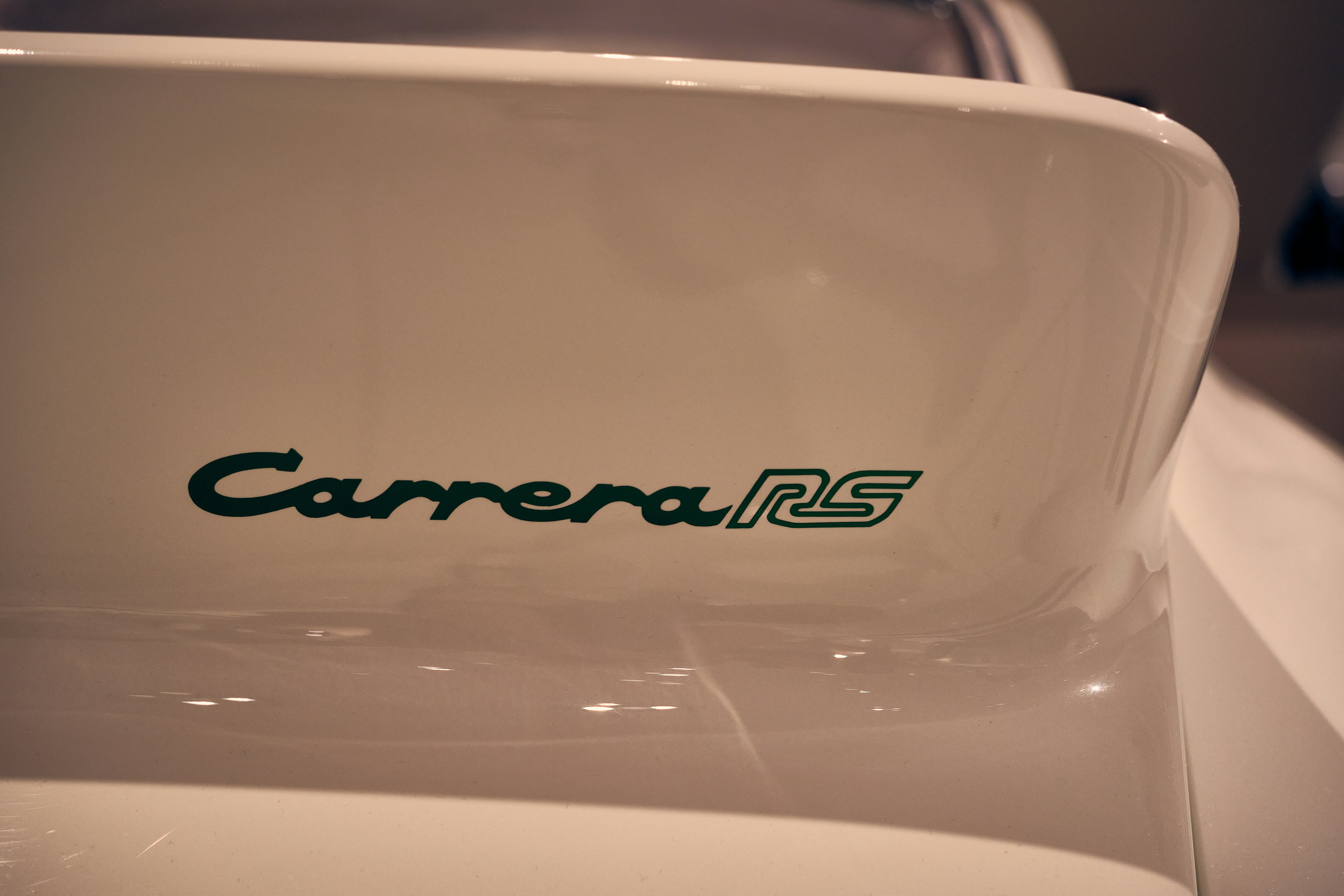 Sleek Carrera RS Badge on a Glossy White Shell