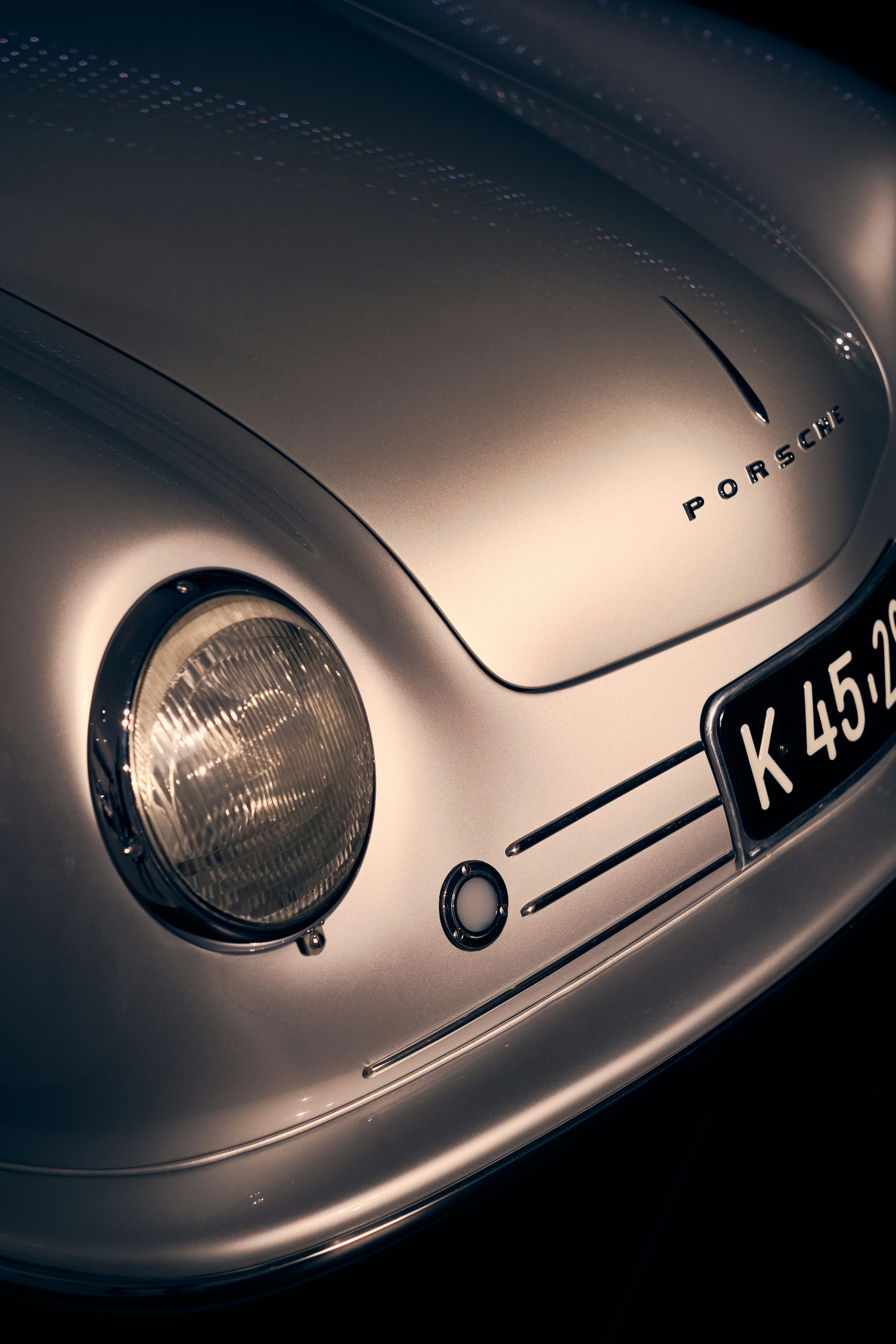 Curved chrome glamour: a vintage Porsche portrait in low-contrast light