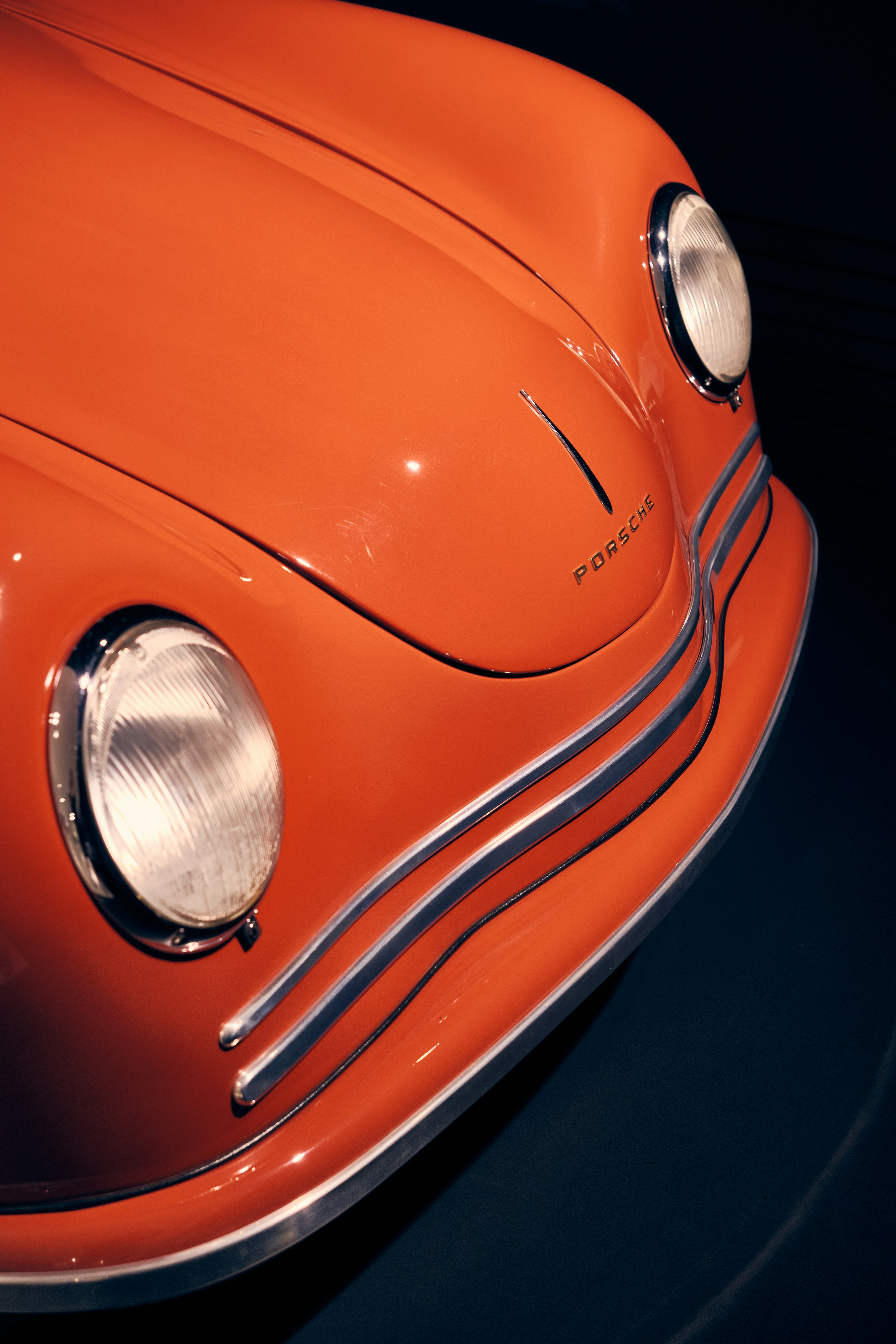Curved Orange Classics: Front View of a Vintage Porsche