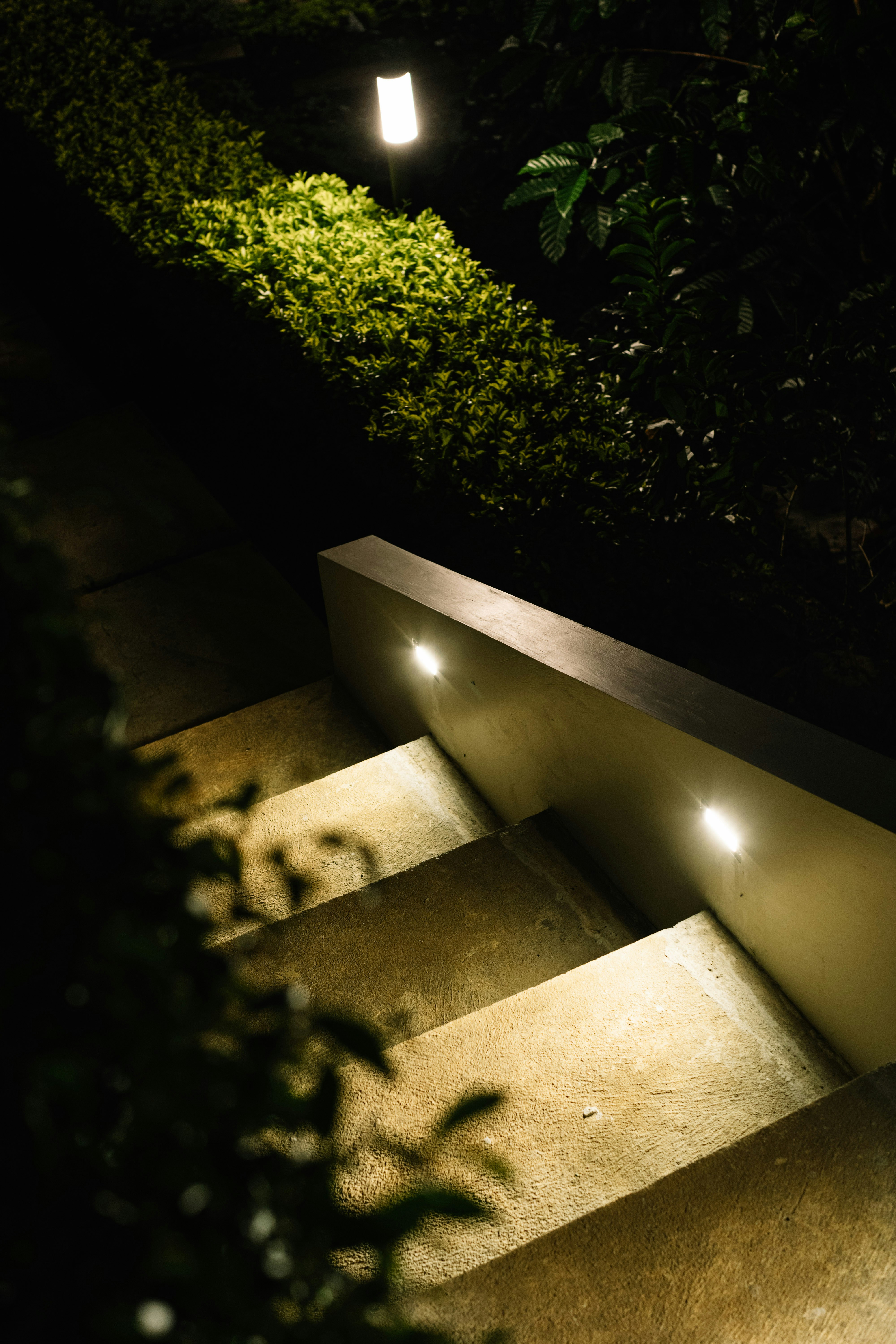 Night descent: illuminated stairs fade into shadow