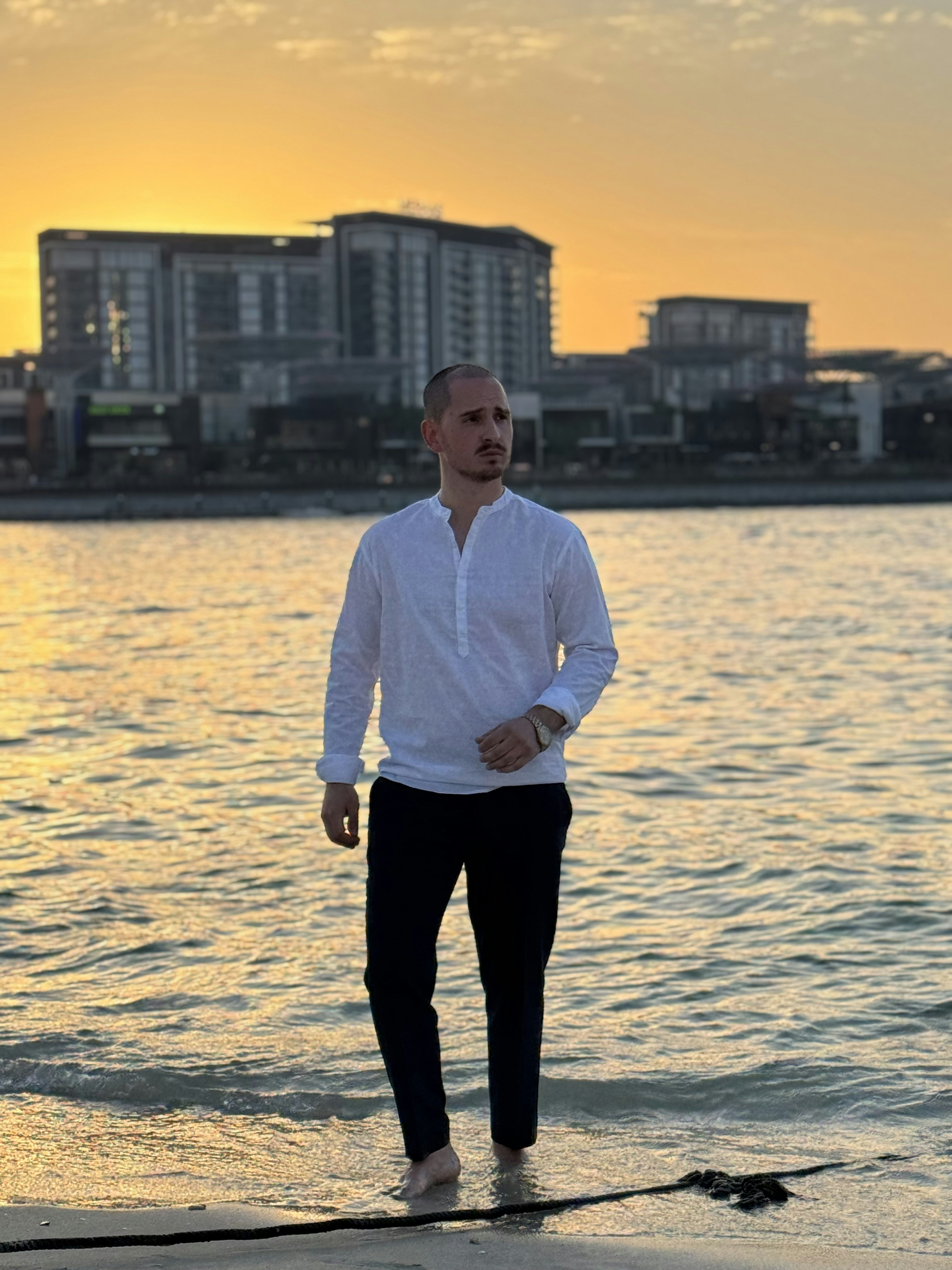 Man on the Shore at Sunset: Calm Confidence by the Water