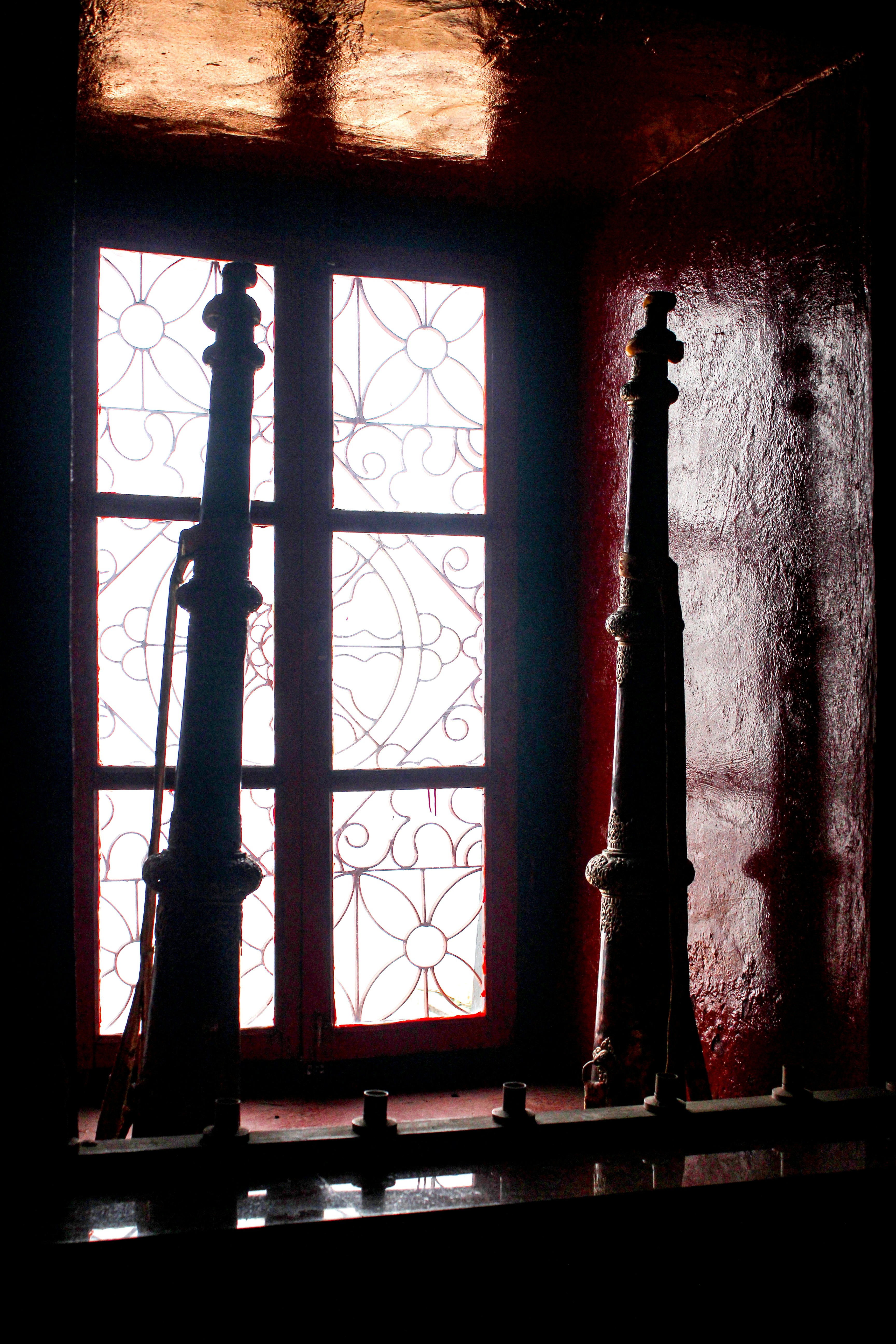 Stained Glass Glow Beyond Dim Ironwork